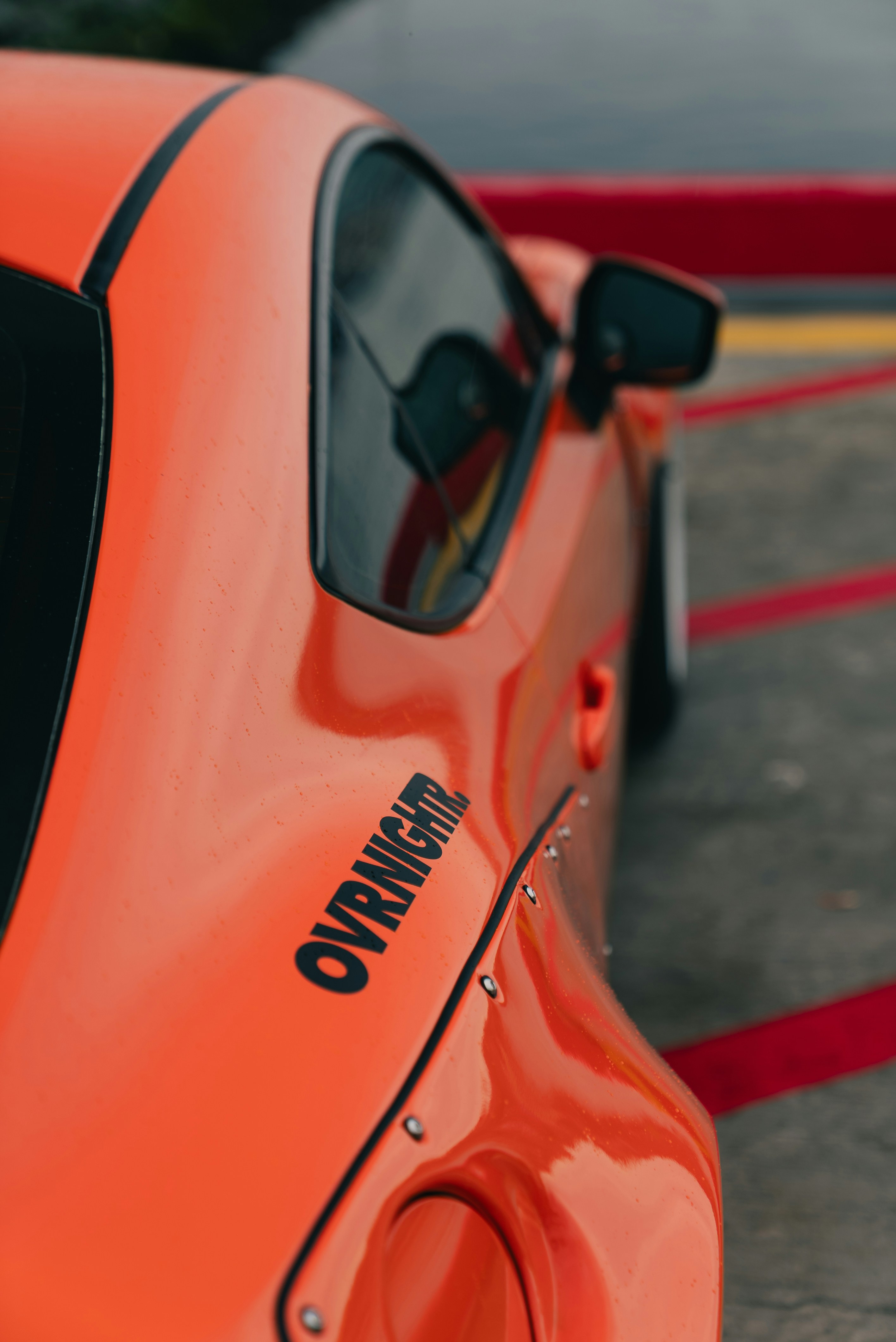 Orange Velocity: A Glimpse of the Side Panel and Graphite Reflections