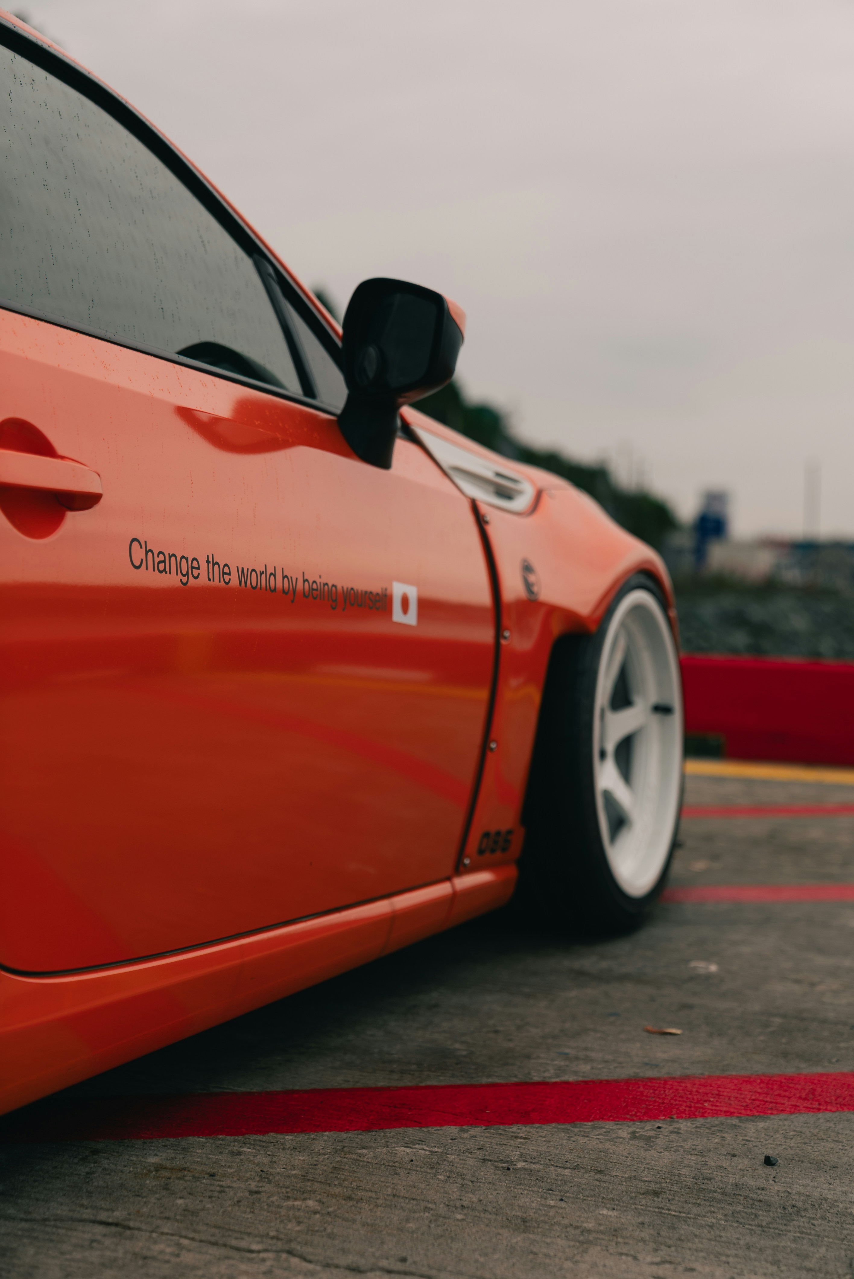 Orange Horizon: Low-Angle Profile of a Sportscar at Ground Level