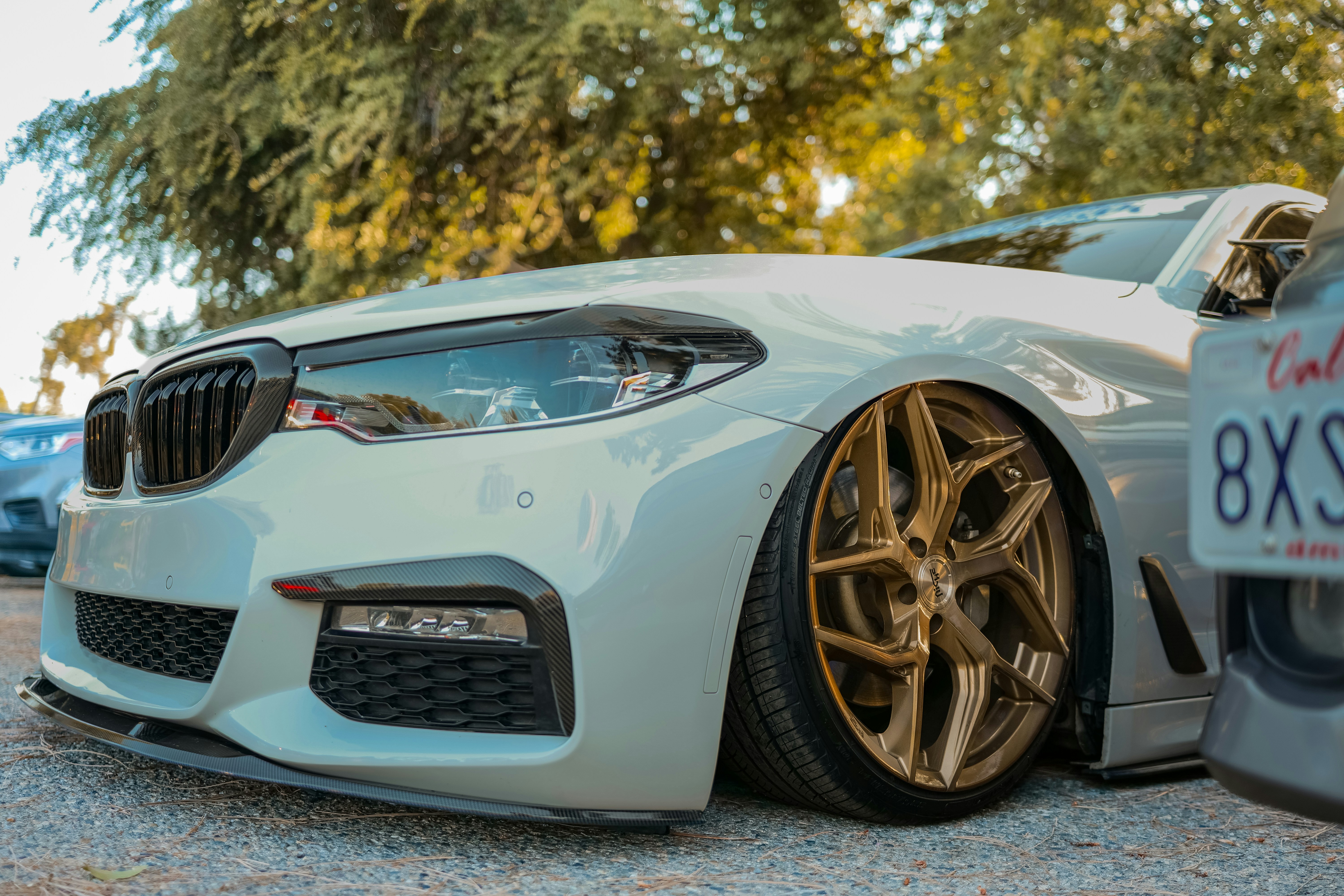 Low-Angle Stance: White BMW Grabs the Spotlight with Bronze Wheels