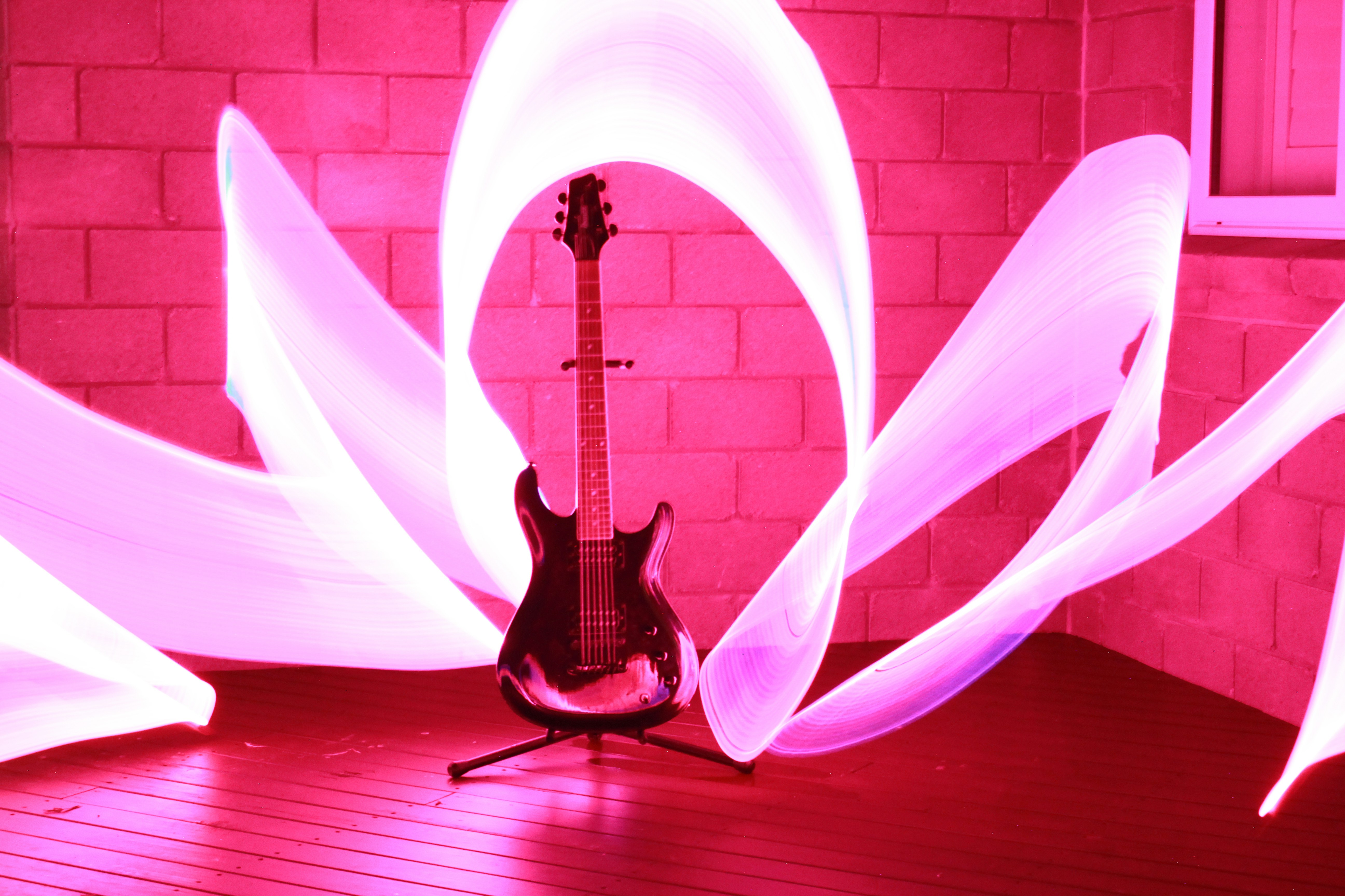 Neon Sonata: Electric Guitar Anchored by Neon Ribbon Echoes