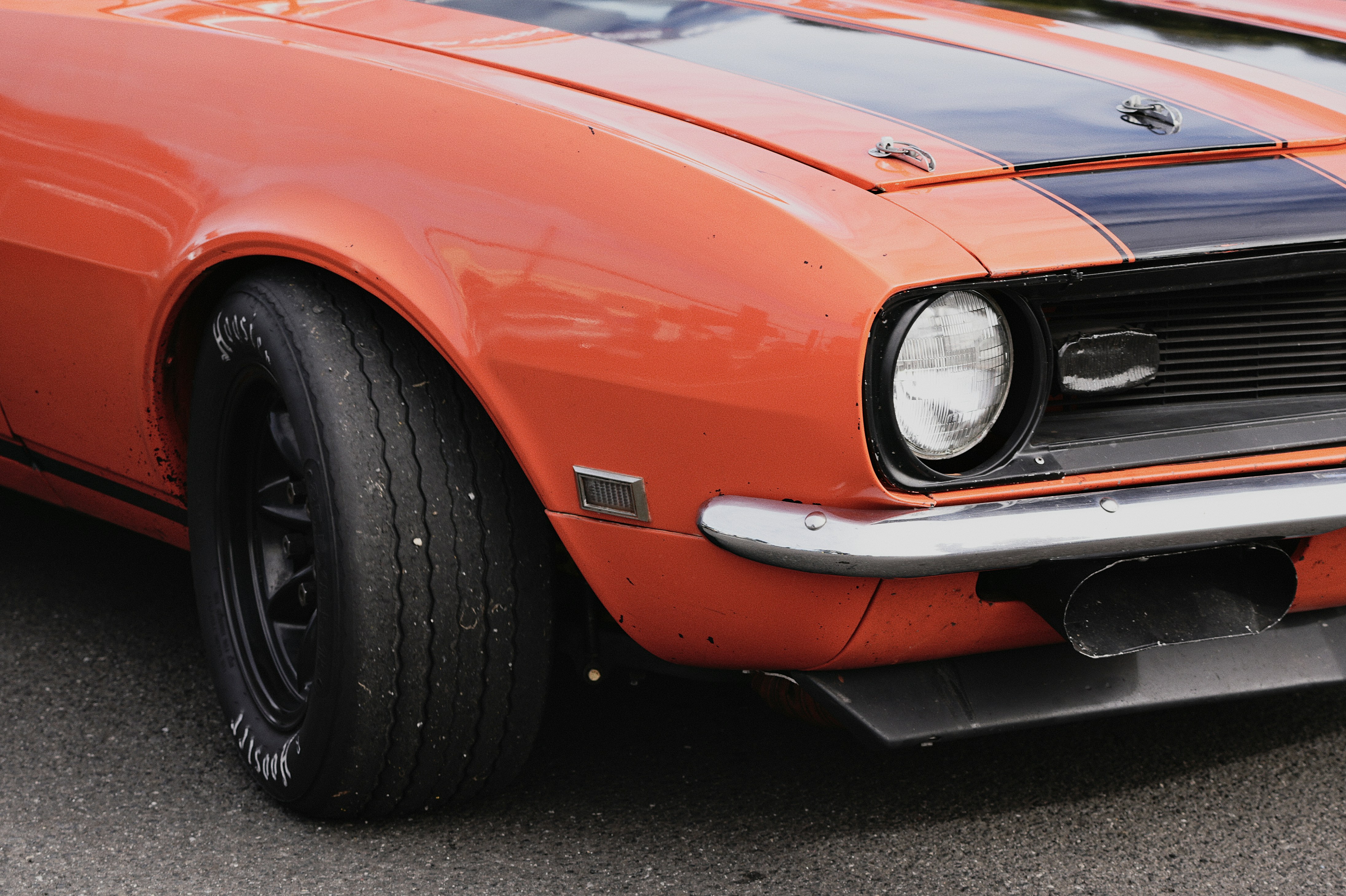 Flared Orange Classic: a close-up of a vintage muscle car's front quarter