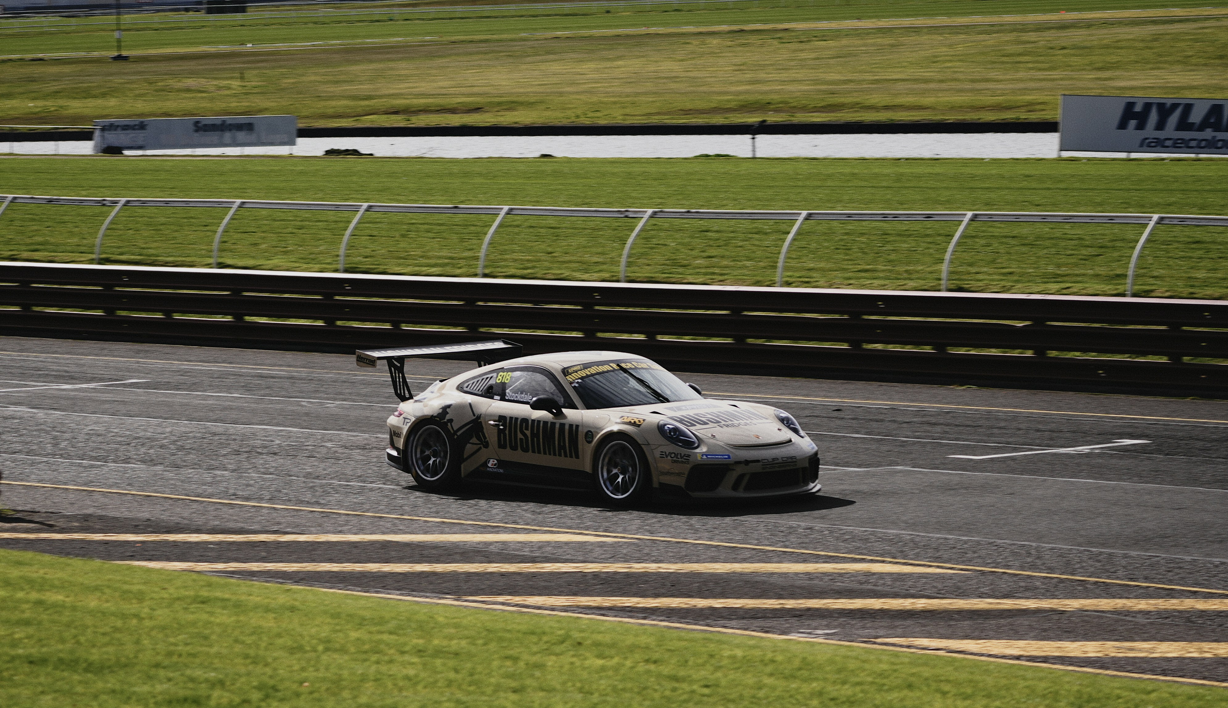 Silver GT Car Glides Past the Track Barriers