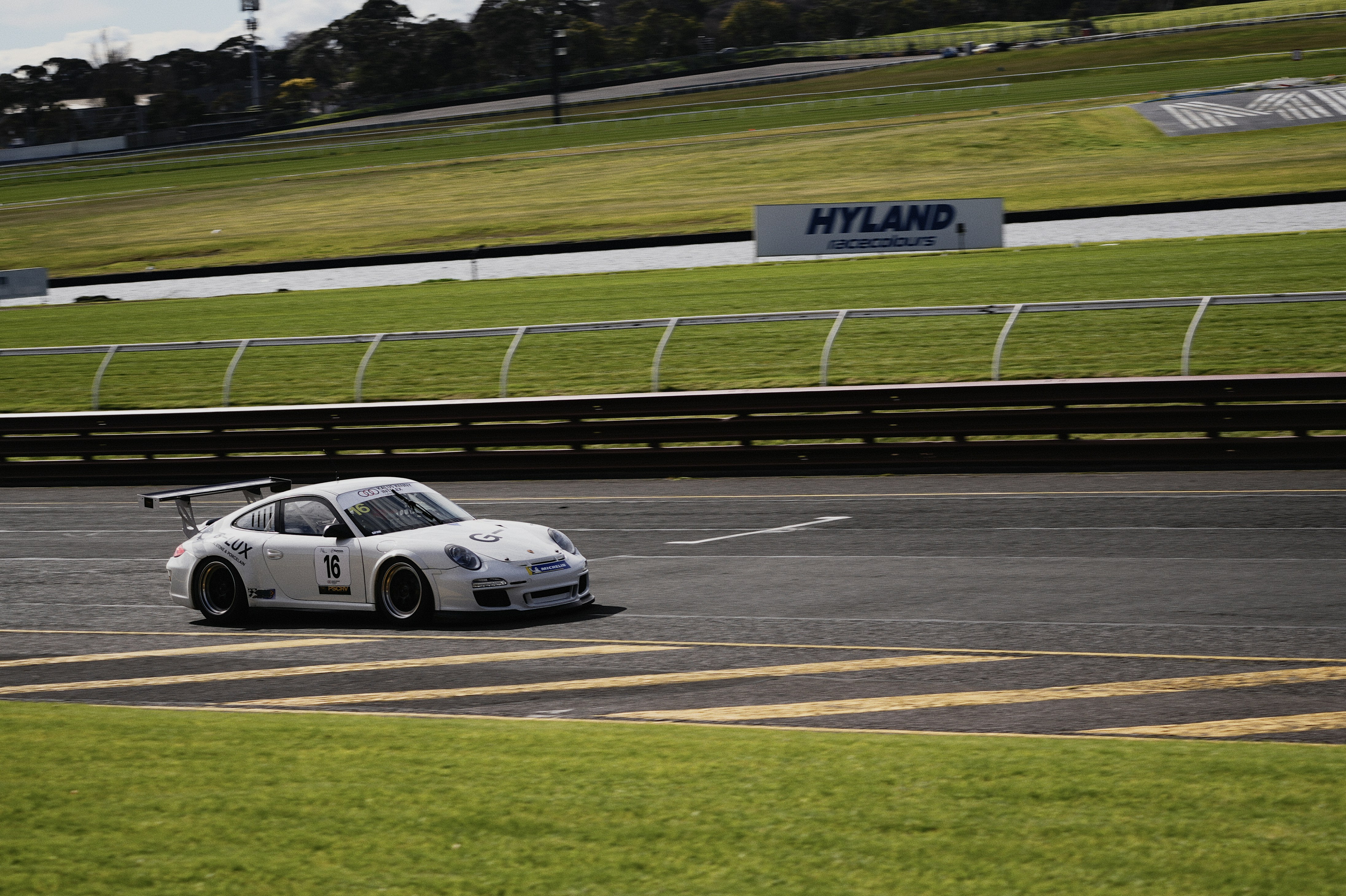 White Porsche on a Race Track: Focused Pace Under Open Sky