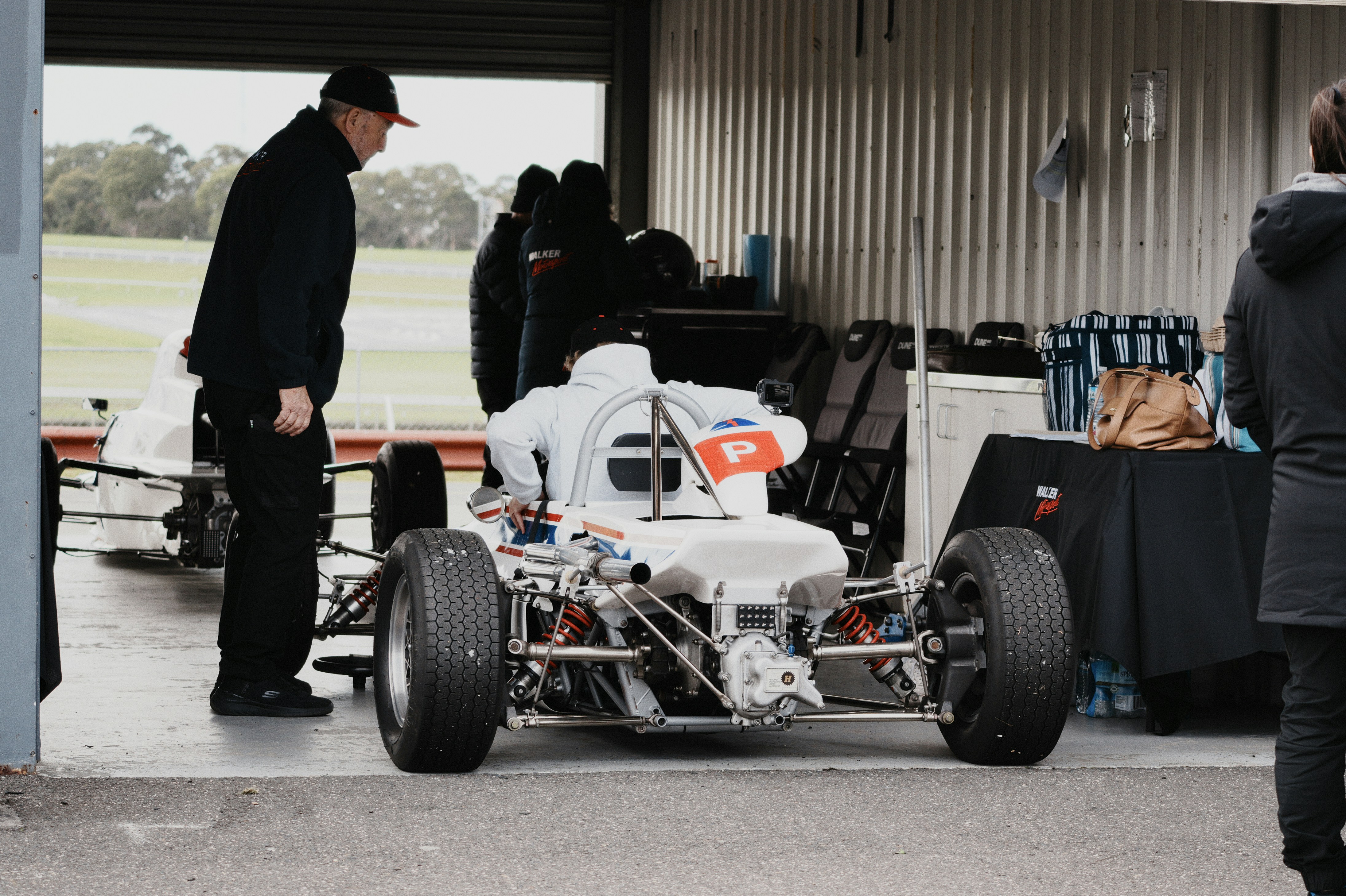 Pit-side Run: Exposed Chassis and Crew at Work