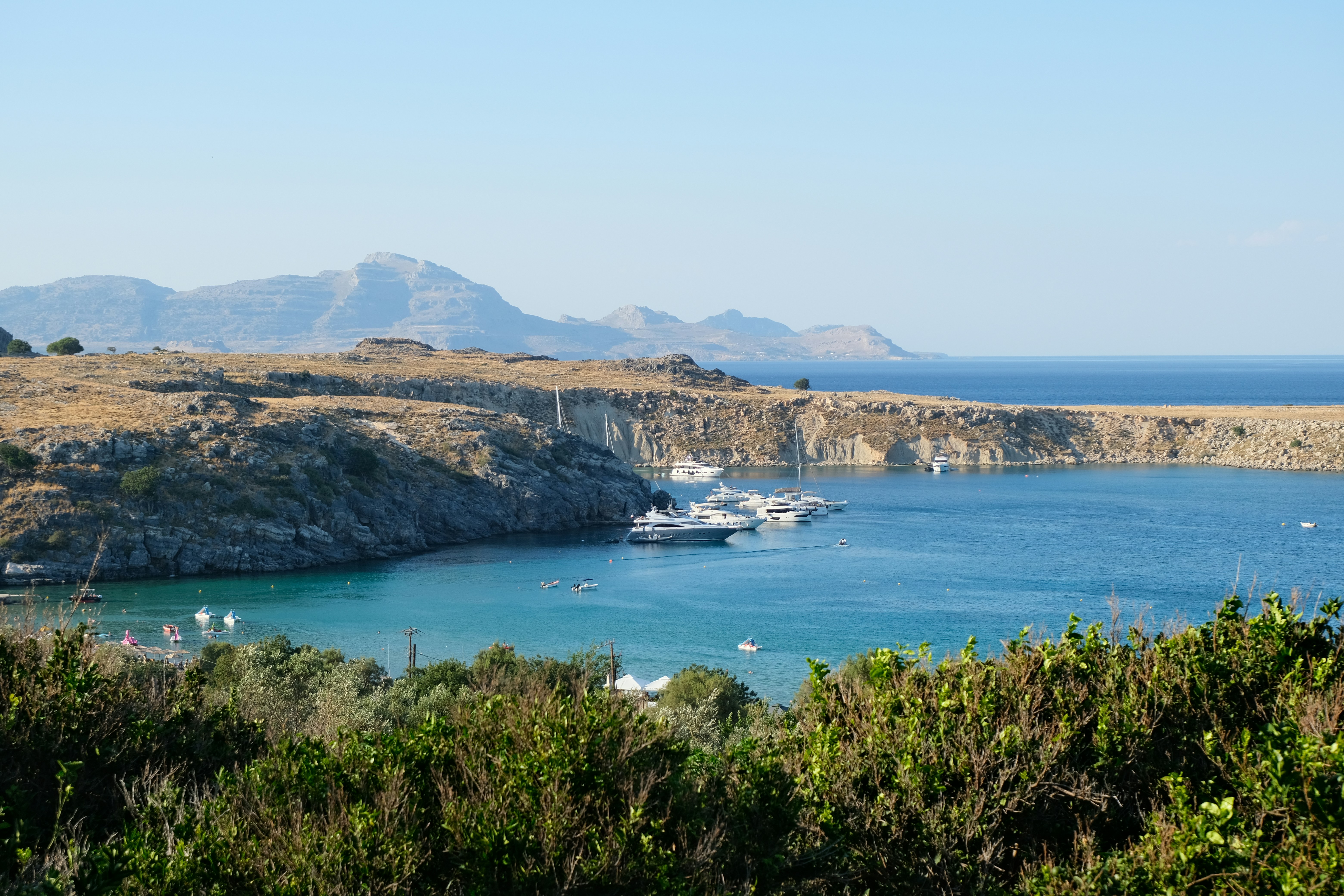 Harbor Cirtha: A Sunlit Cove Framed by Distant Cliffs