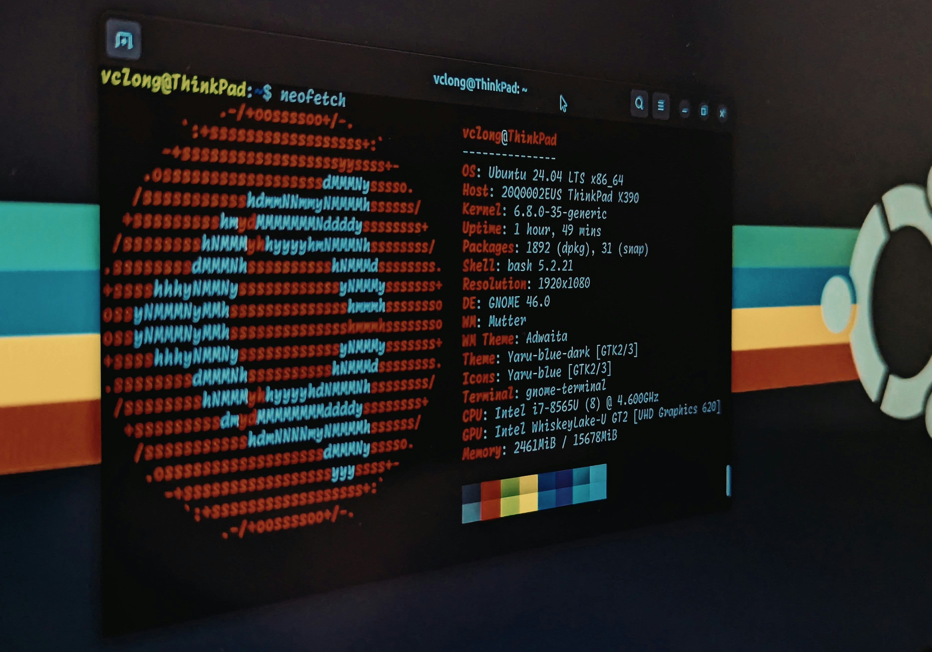 A computer screen displaying system information and an Ubuntu logo in a terminal window