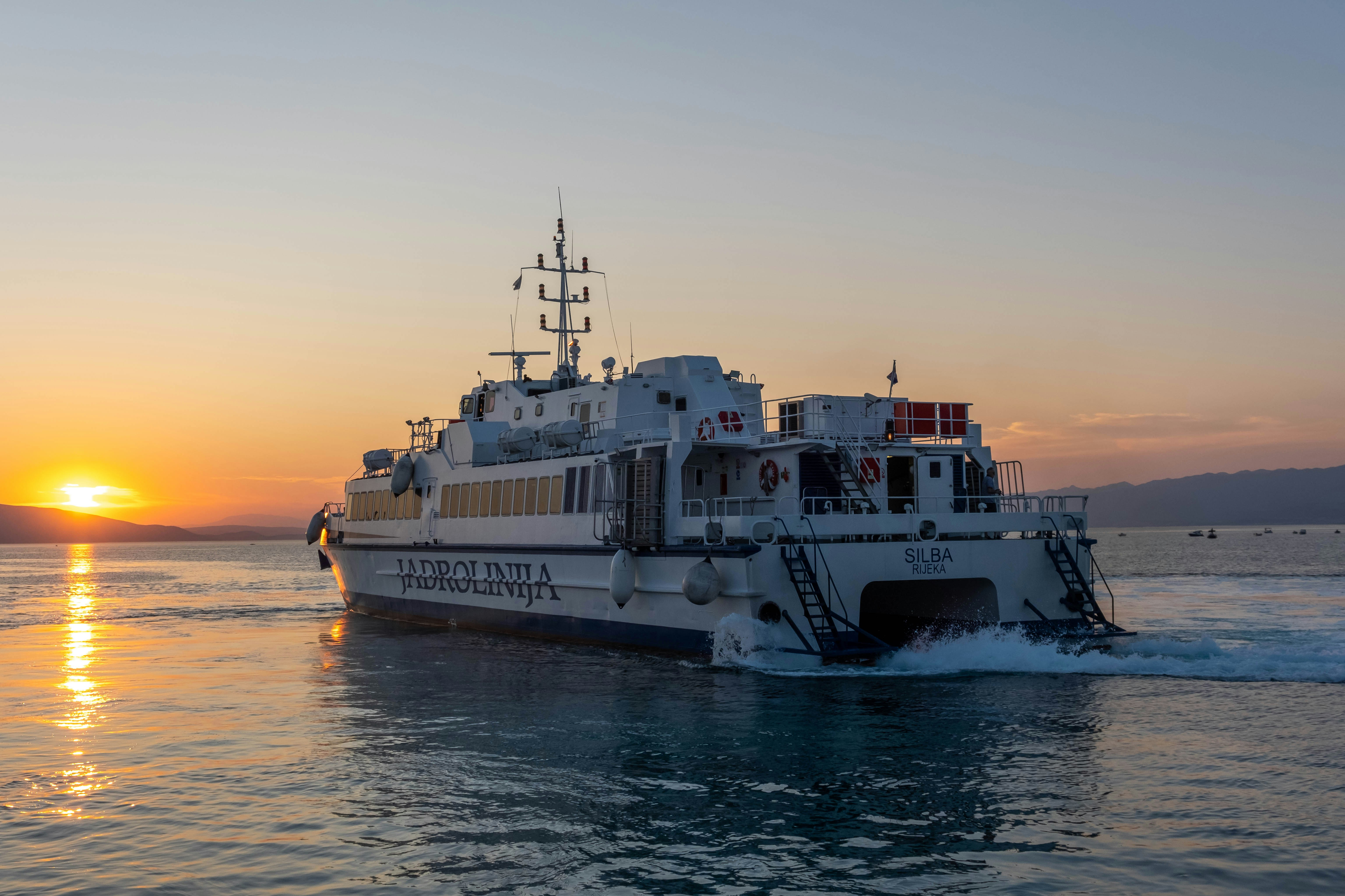 Sunrise Ferry: A Dawn Crossing Past Calm Waters