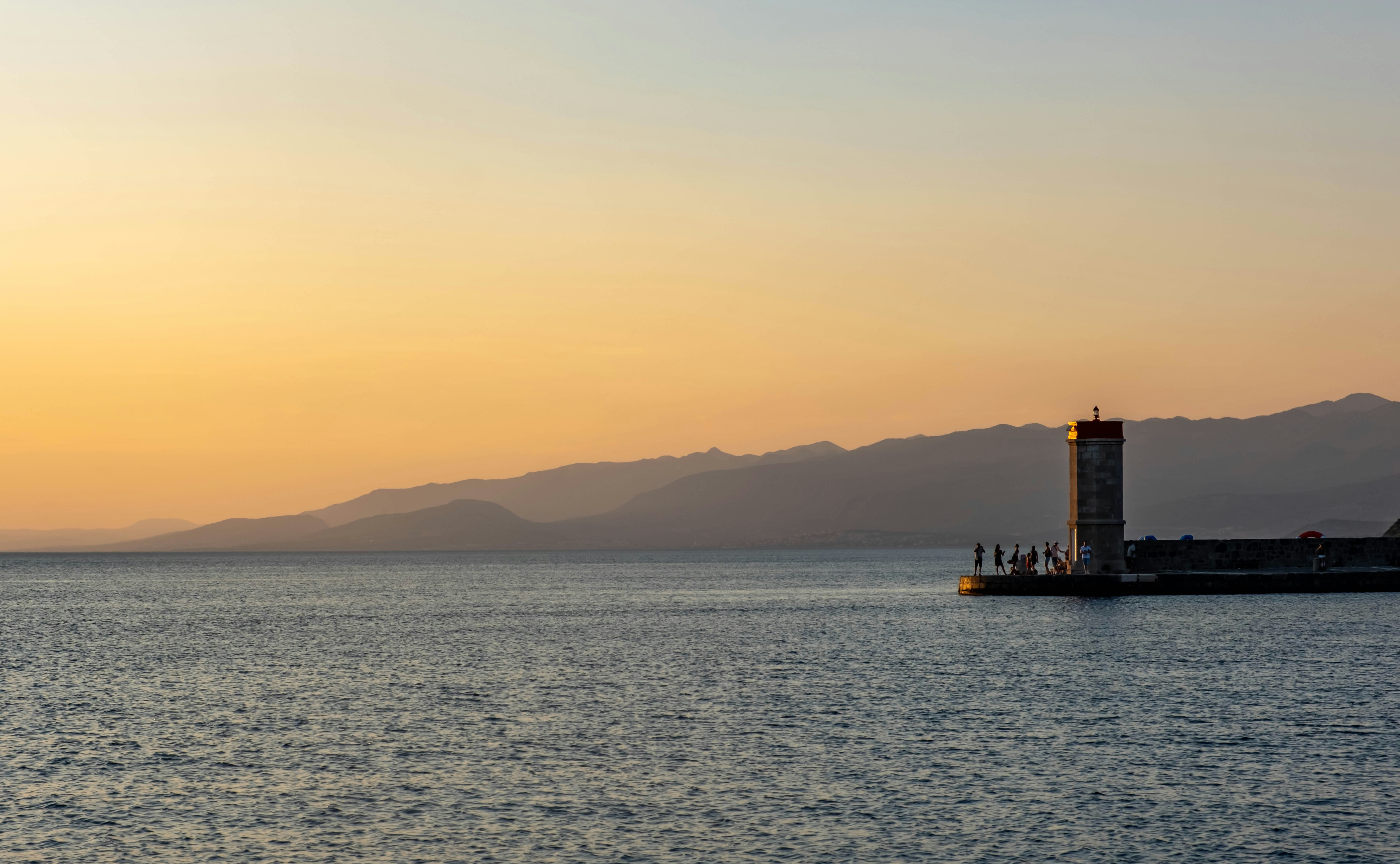 Lighthouse at Dusk: A Tranquil Pier Embraced by Sunset