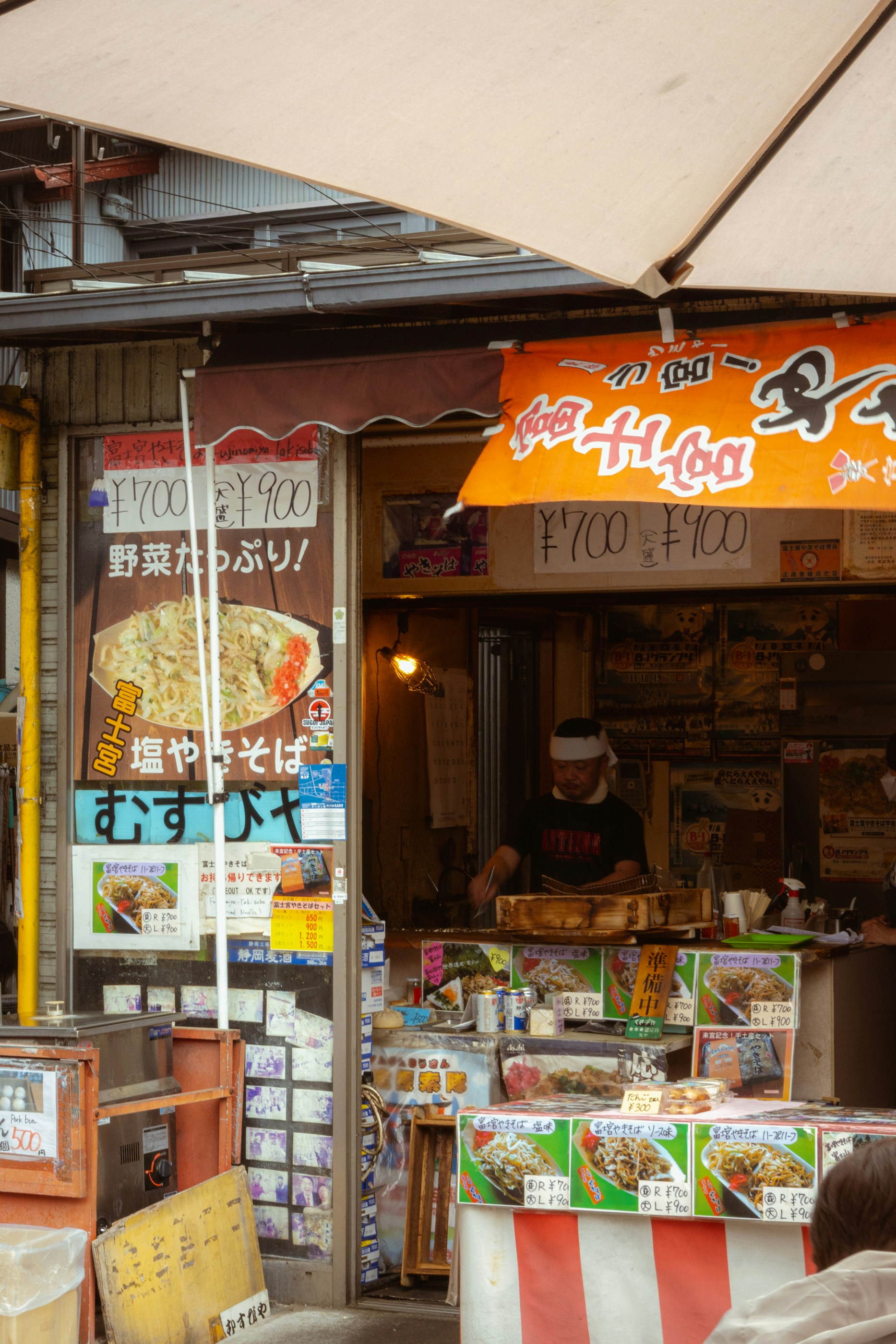 Street Vendor Theater: Flame-lit Griddle Amid Bright Signage