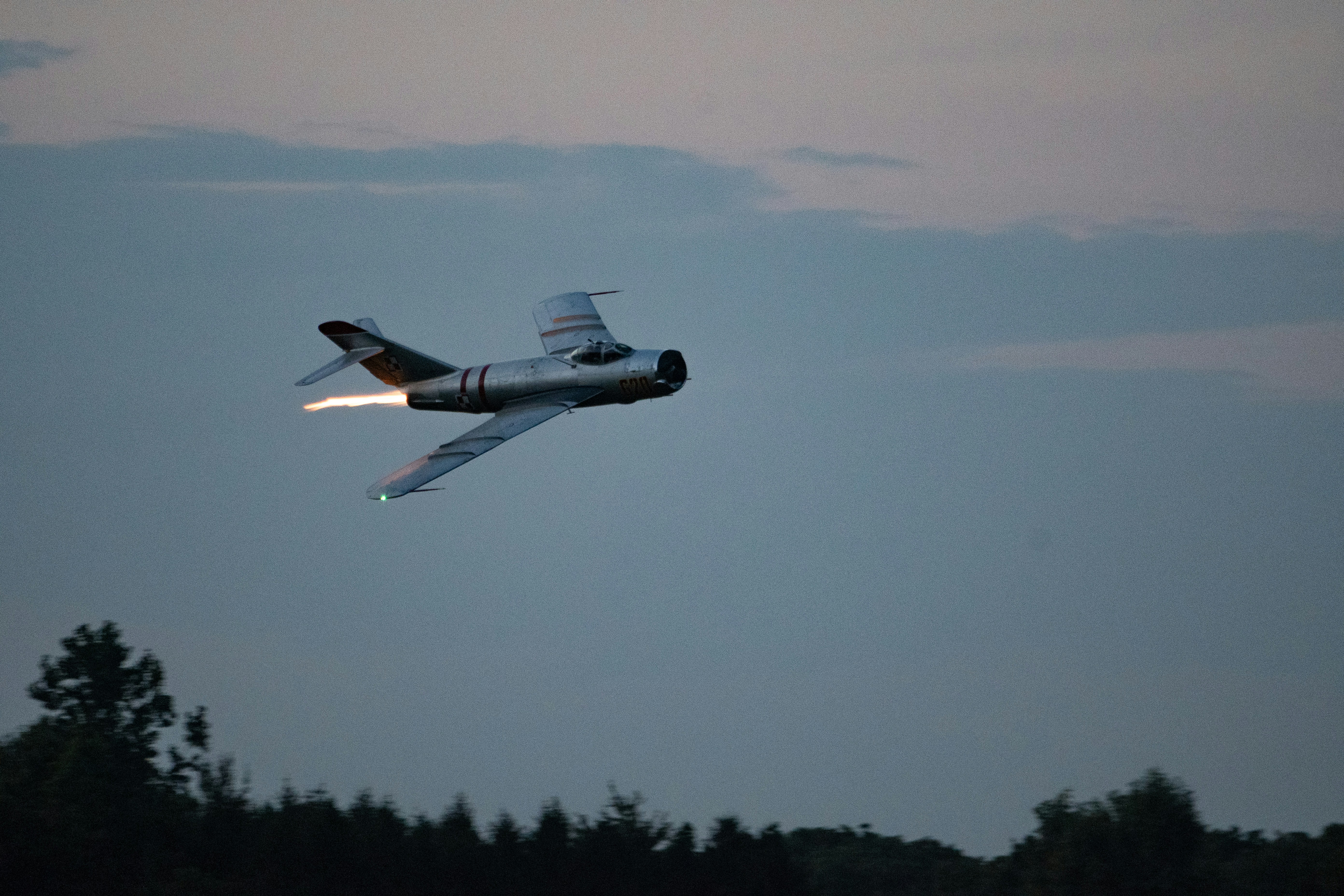 Jet at Dusk: An Airborne Glint Over Quiet Timberline