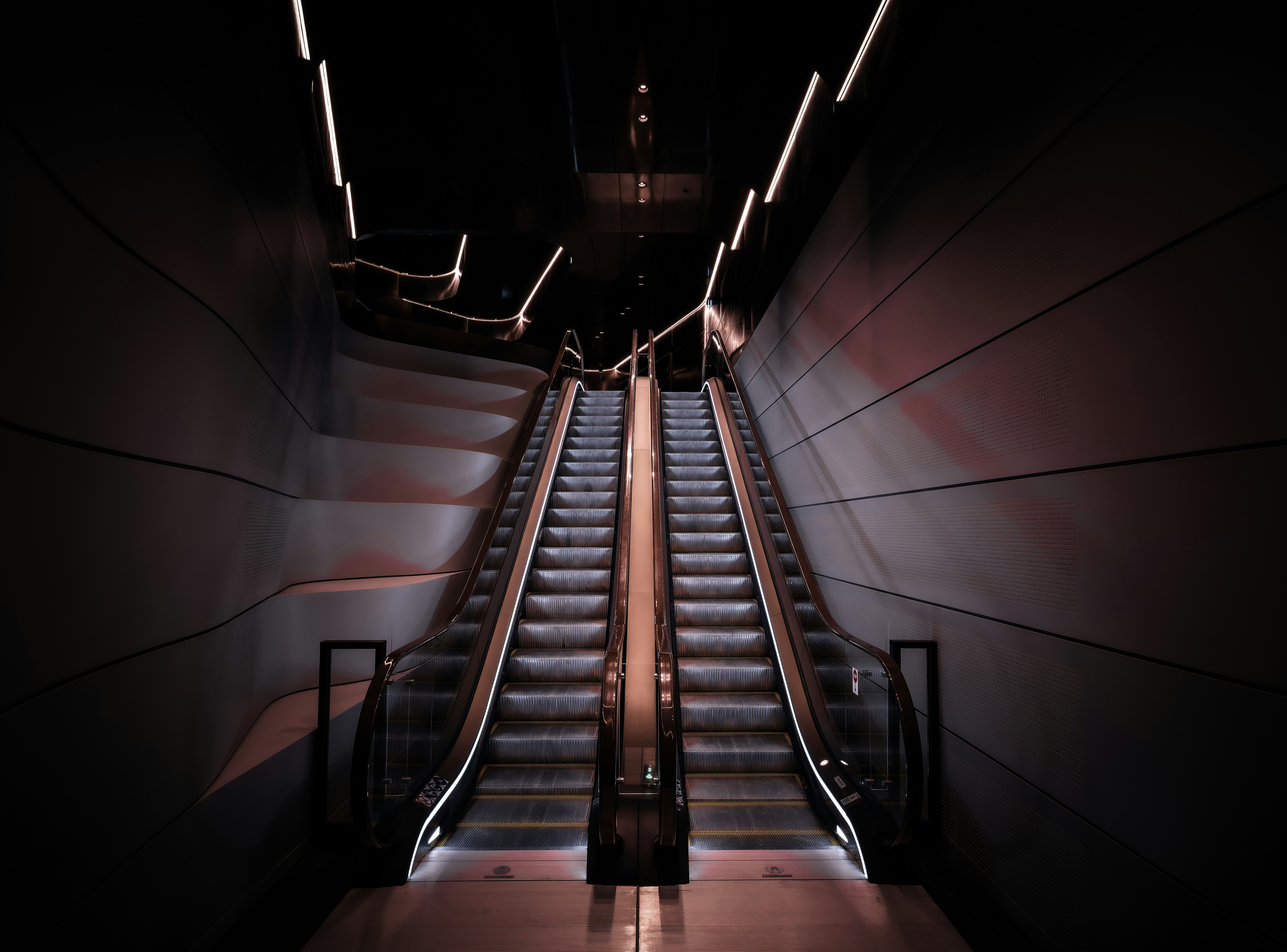 Midnight Descent: Neon-Outlined Escalator Through Dark Corridors