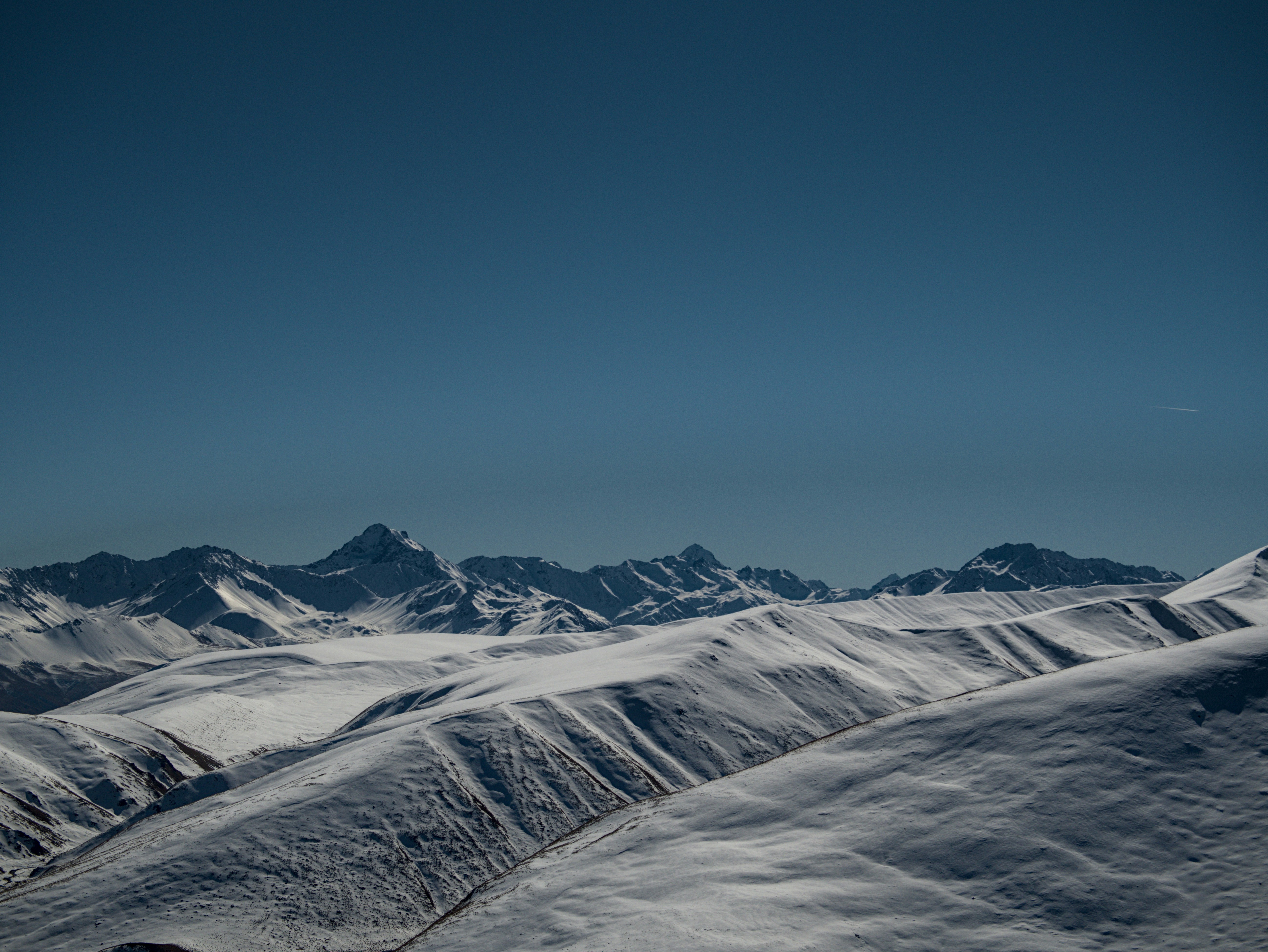 Snowbound Ridge Under a Void‑Blue Sky