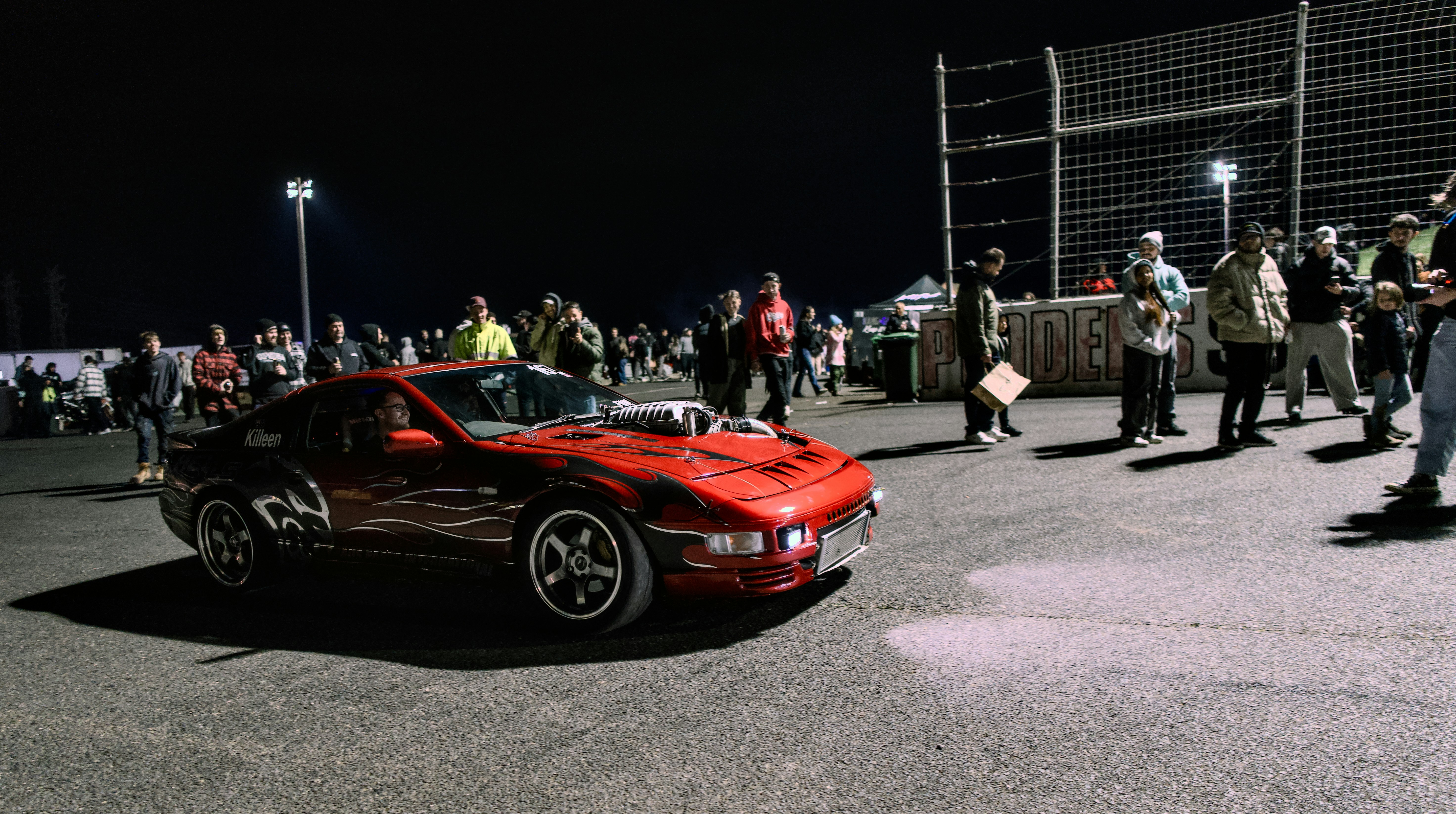 Red Icarus: A Burnished Drift Car Under Night Sky