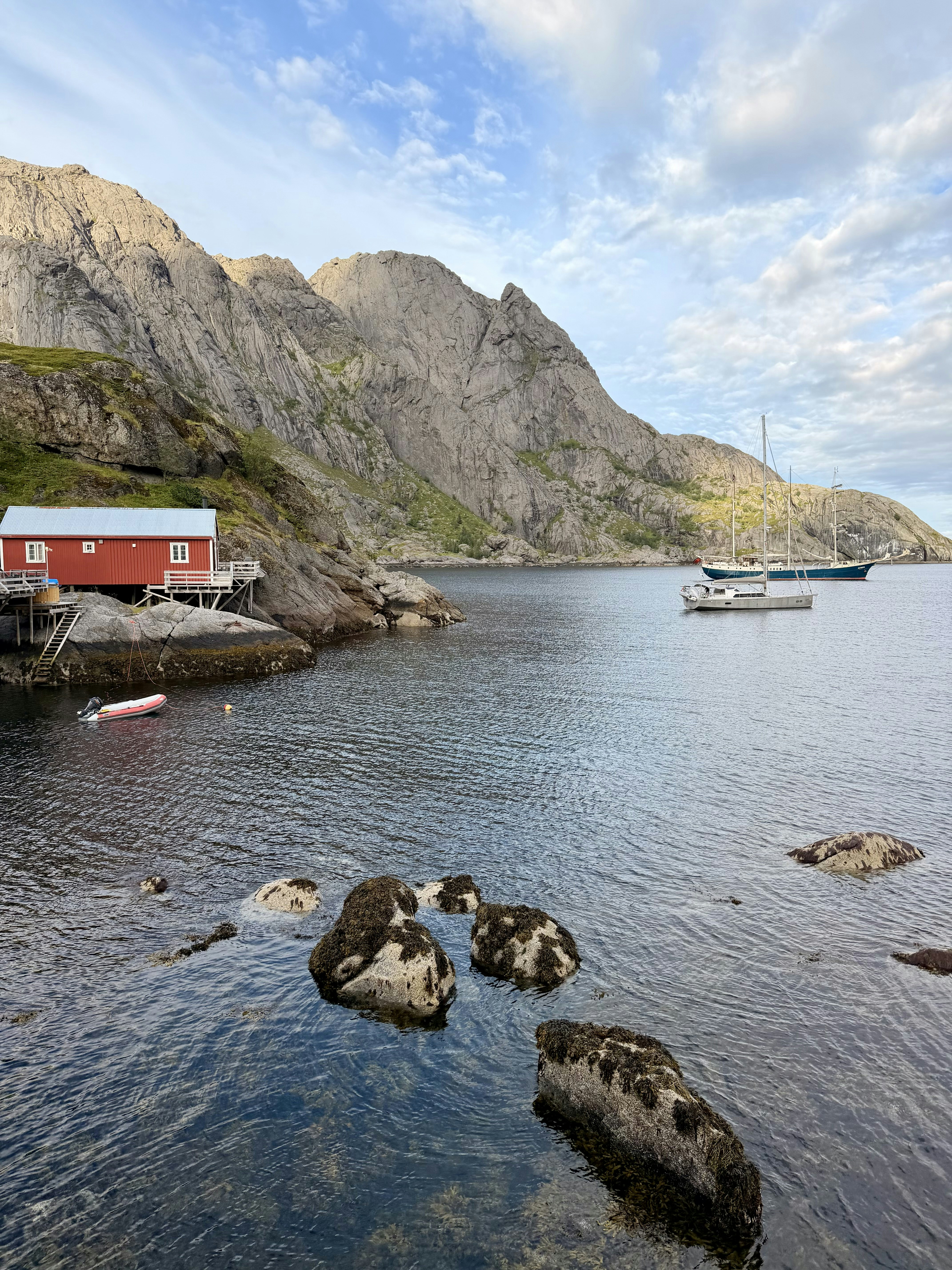 Red Boathouse and Ragged Coastline at Dusk