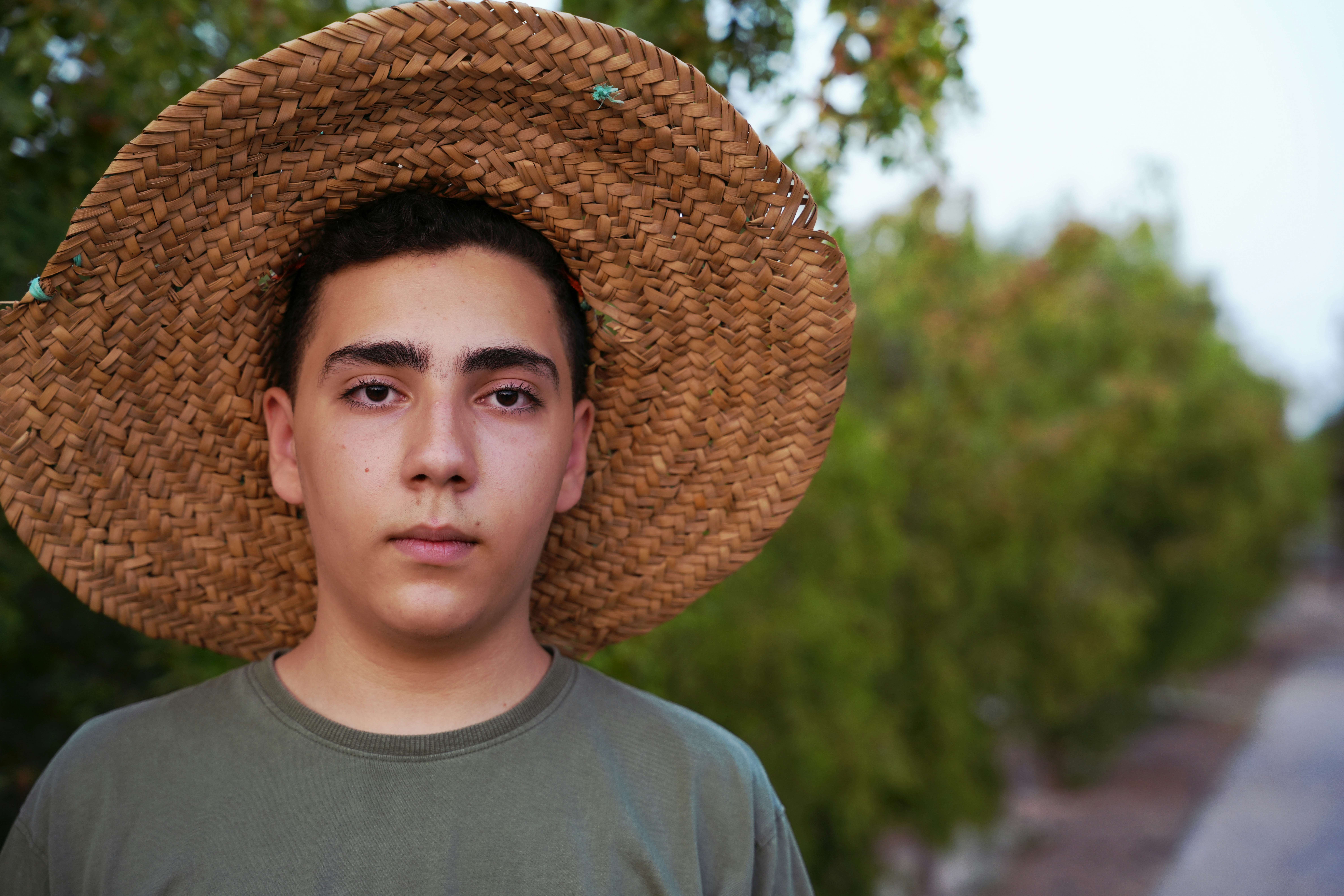 Straw Hat Portrait Under Dappled Light