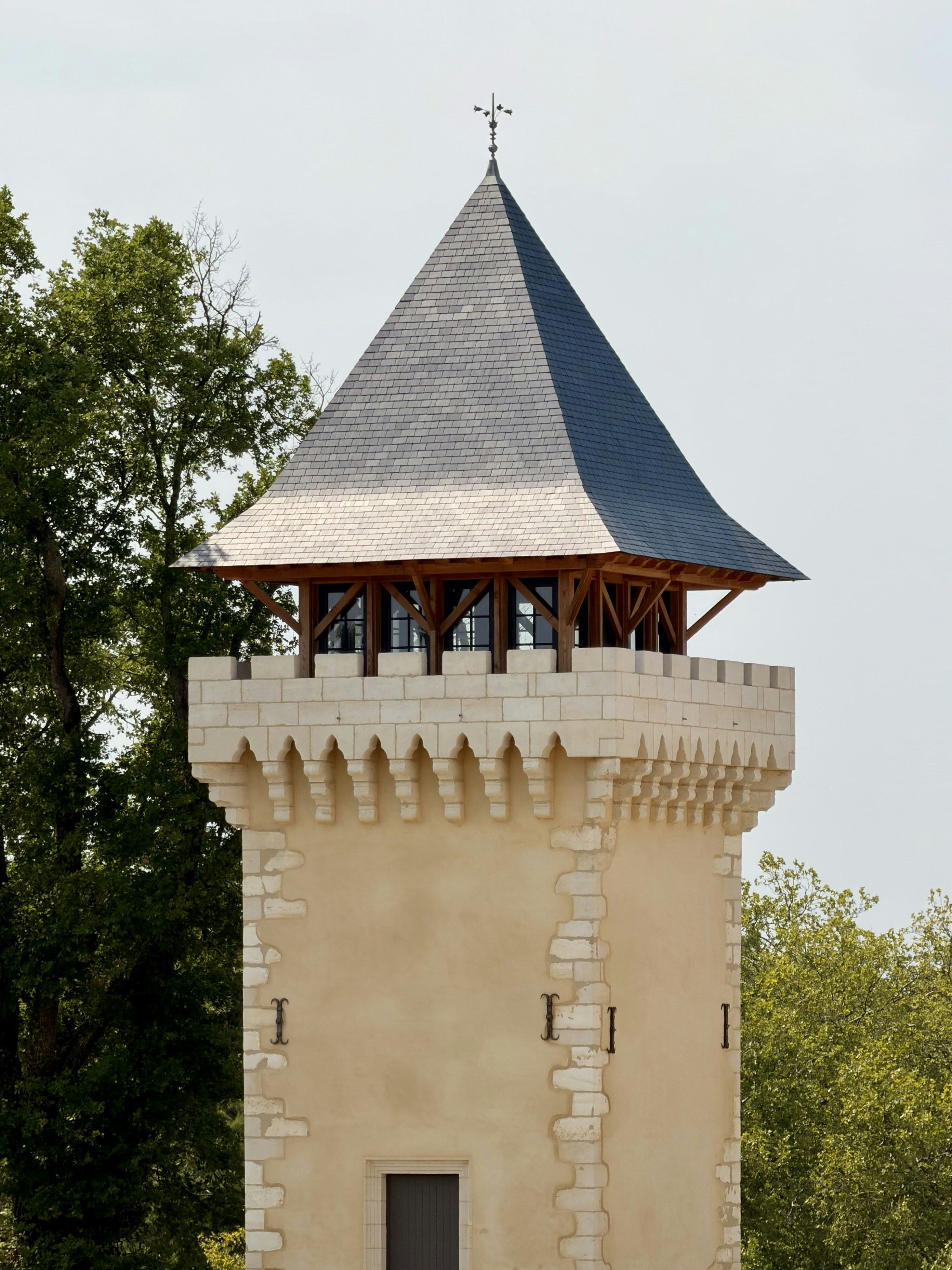 Stone Turret crowned with slate roof and timber balcony