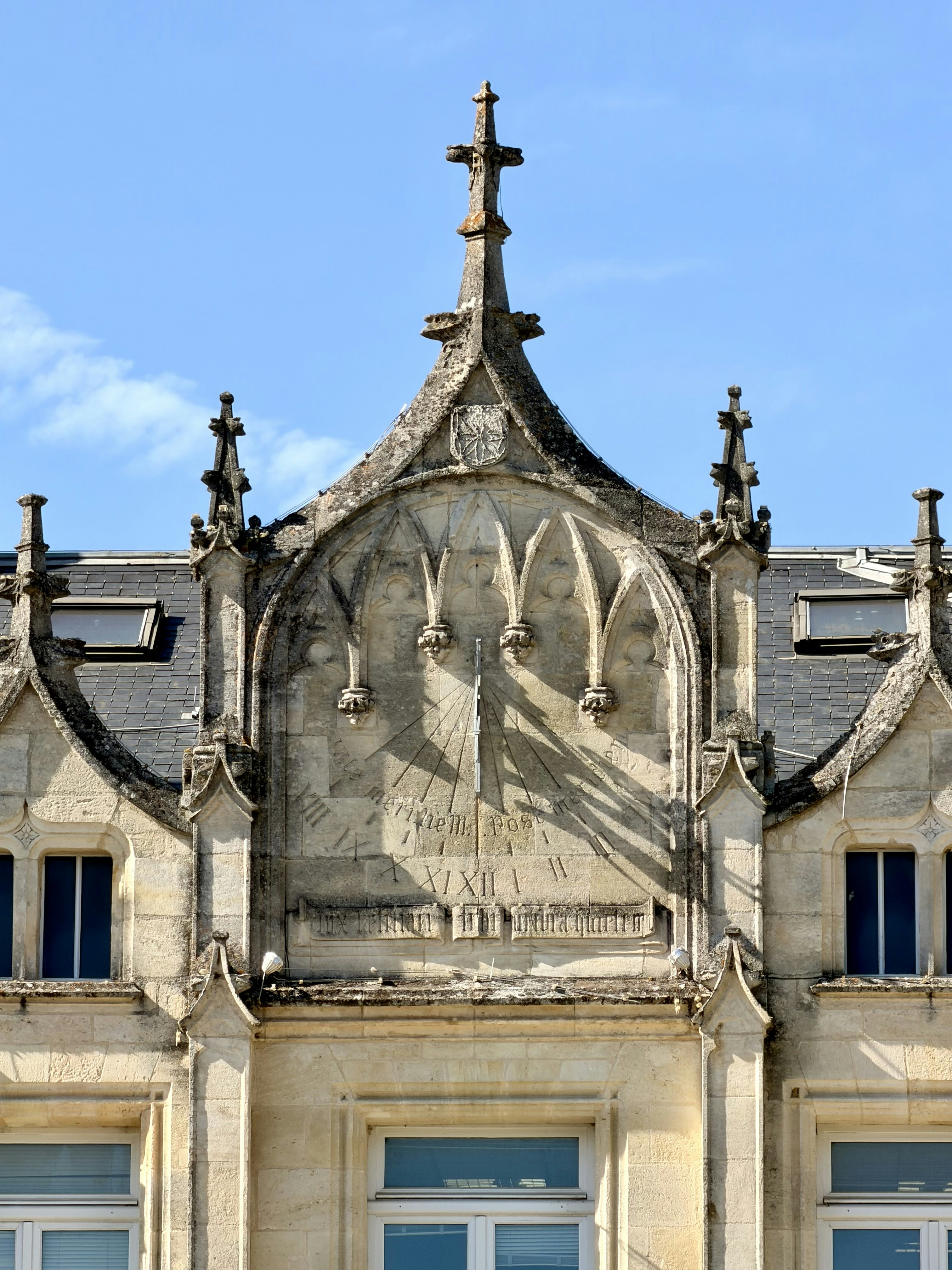 Gothic Facade: A Sunlit Clock Gable On a Historic Roof