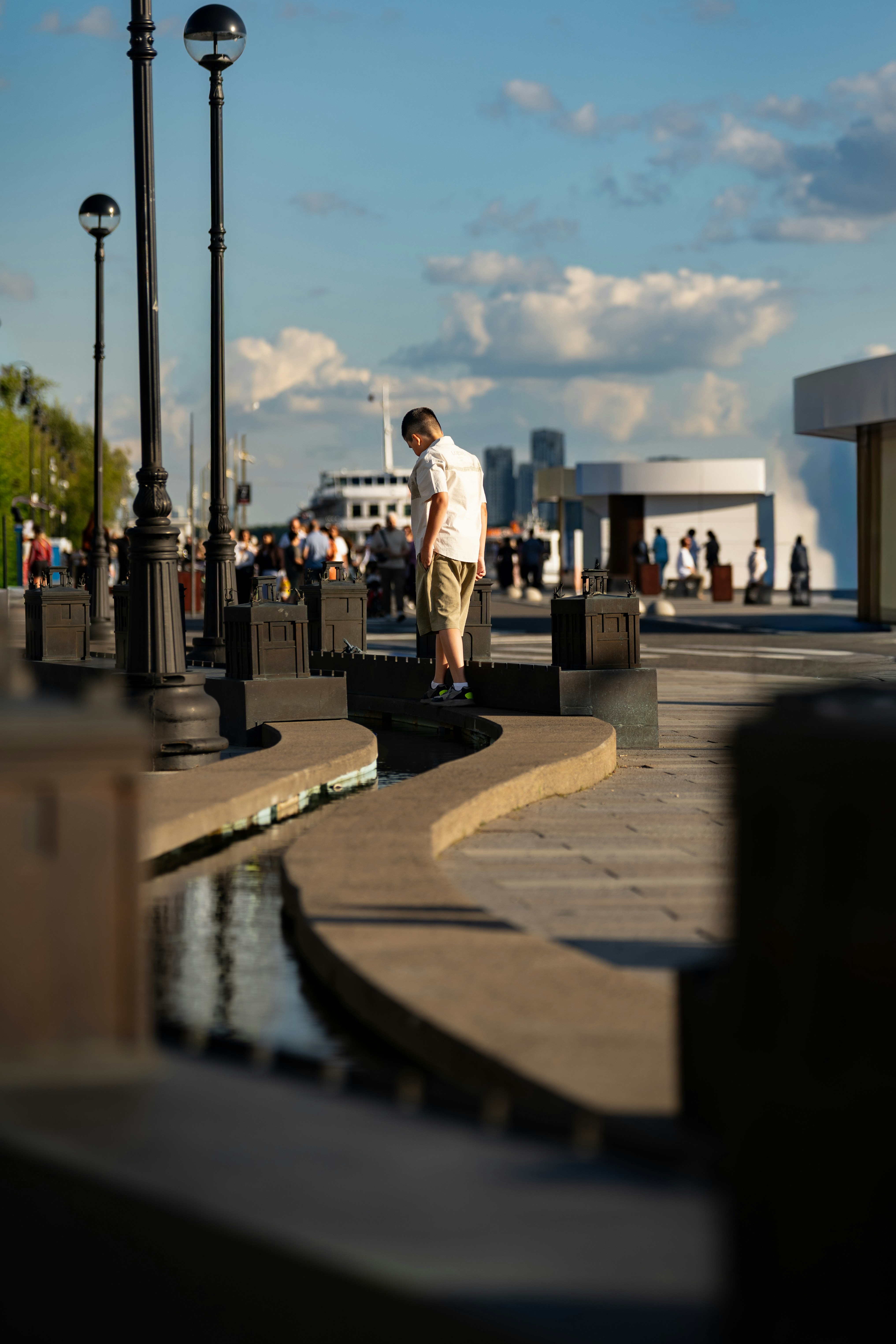 Man on the jetty: a quiet pause among waterfront silhouettes