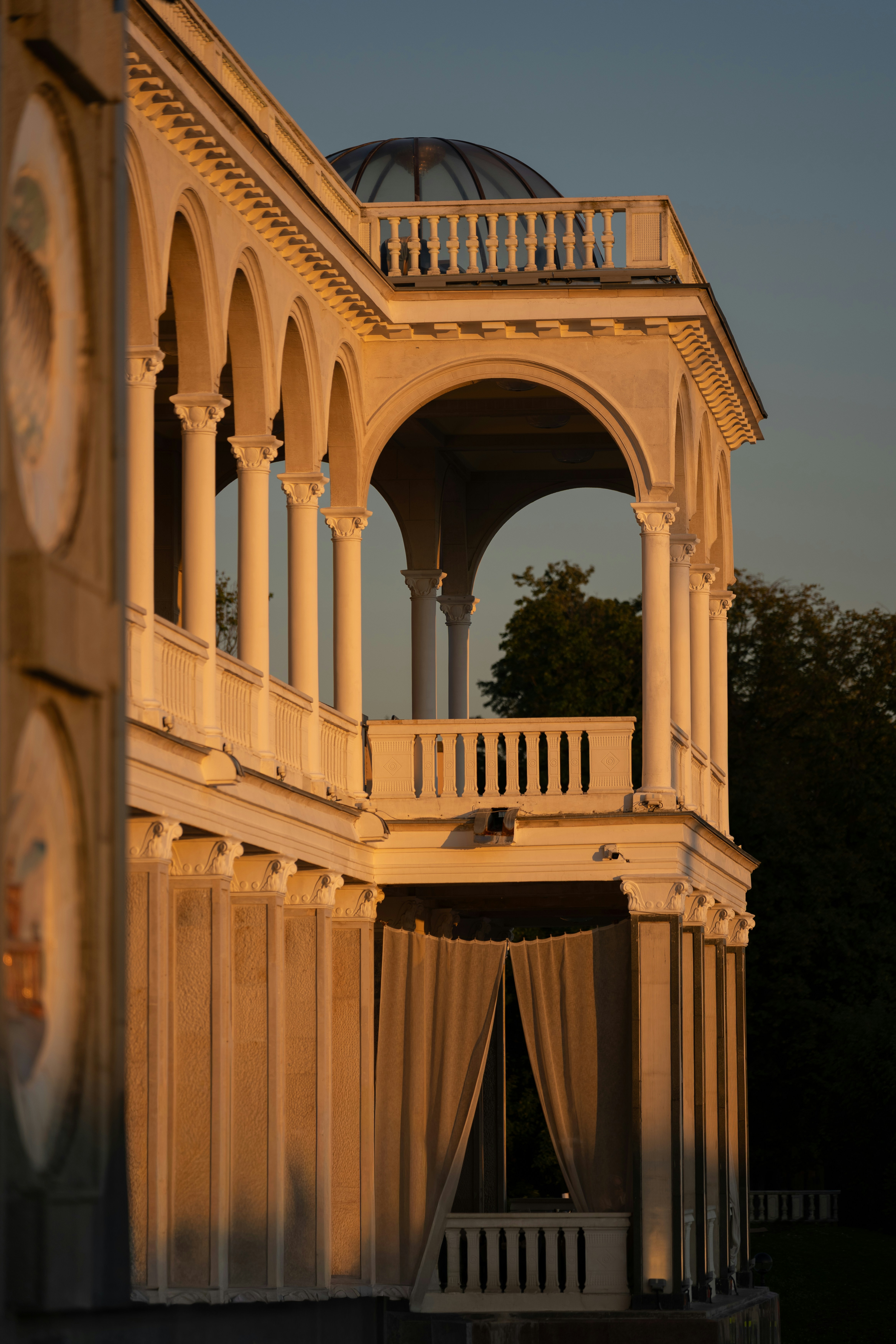 Sunlit Veranda: Arches and Draped Gables in Golden Hour