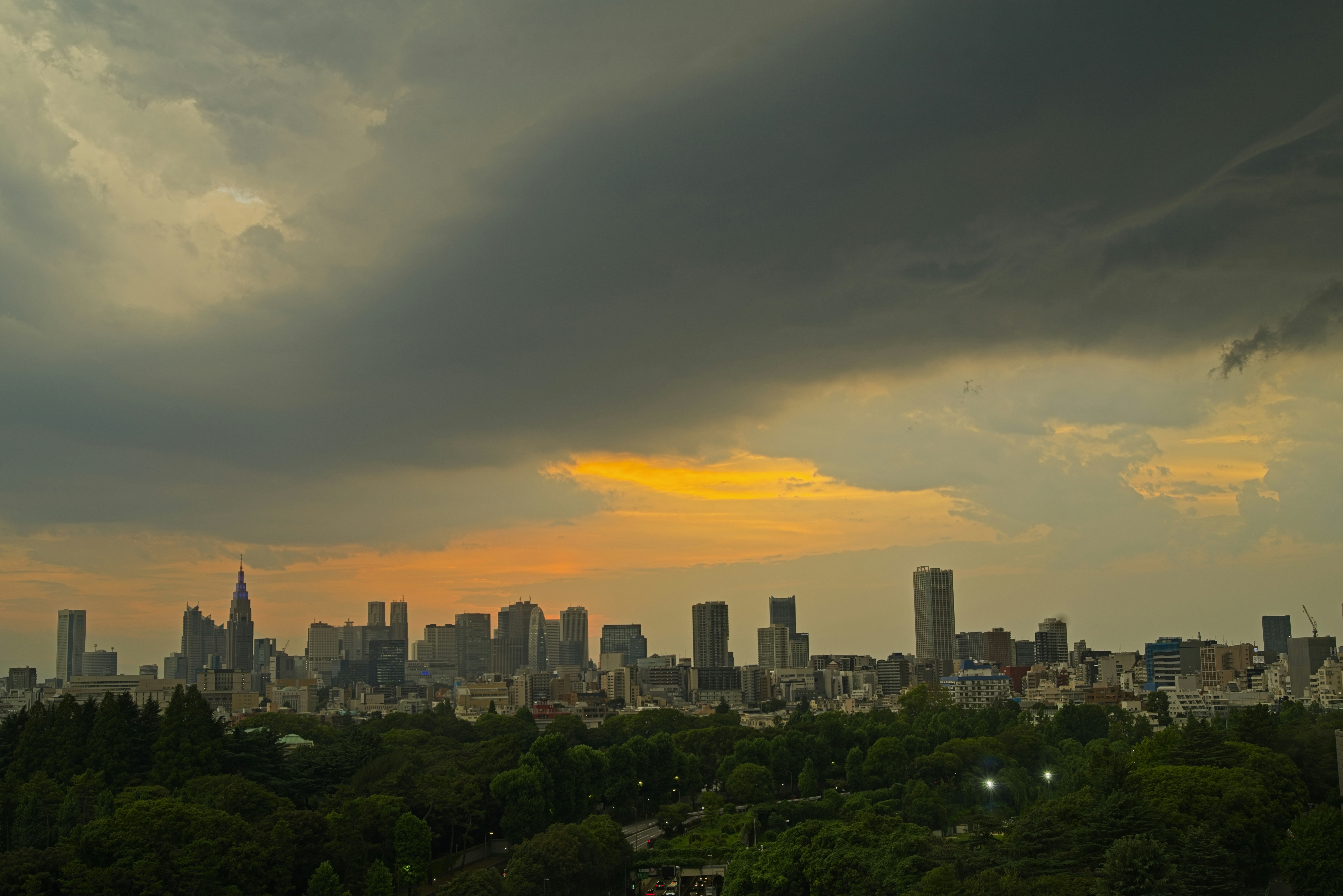 Sunset Over the City: A Quiet Horizon Above the Green Ridge