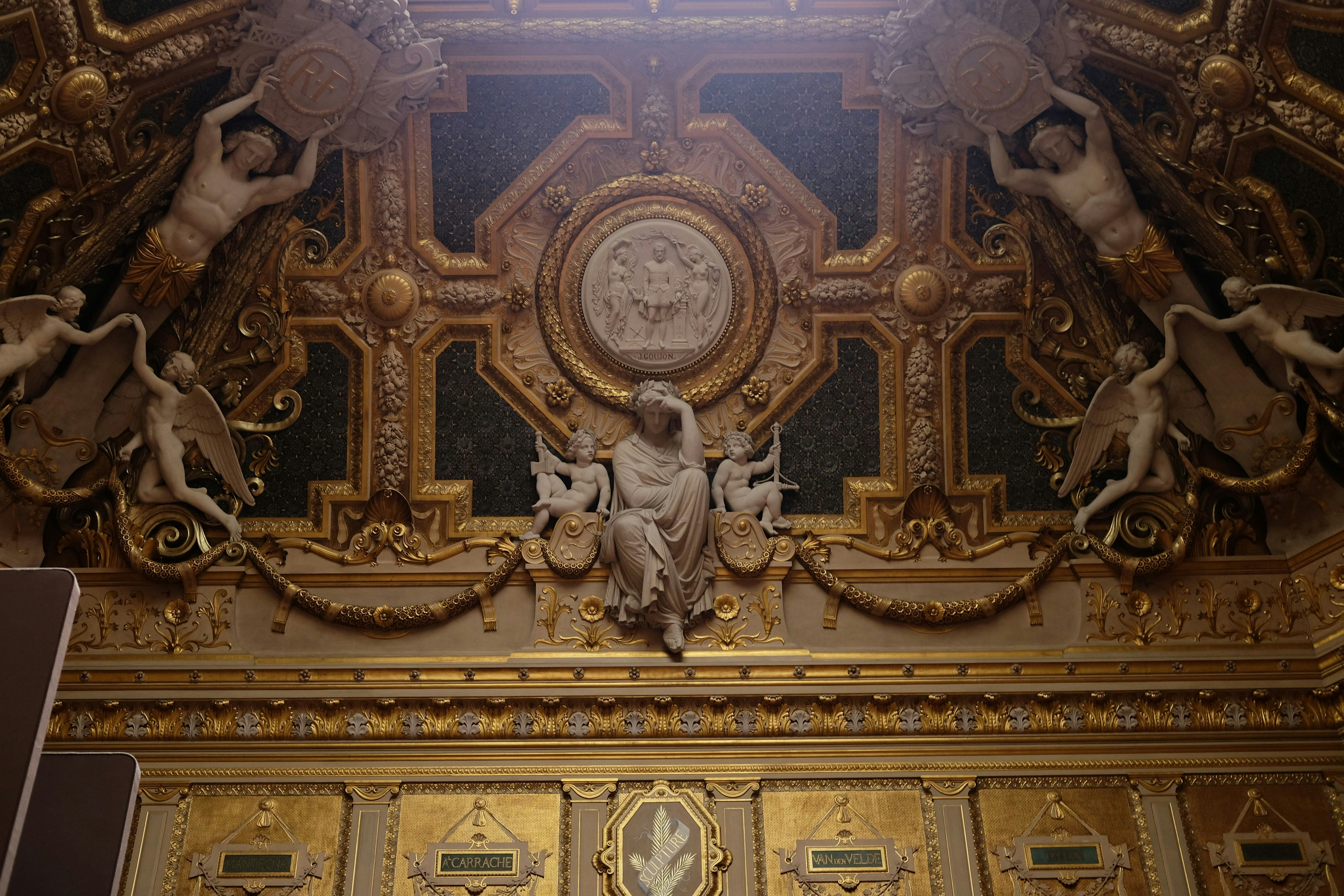Gilded Apex: Sculpted Figures and Ornate Reliefs Above the Altar