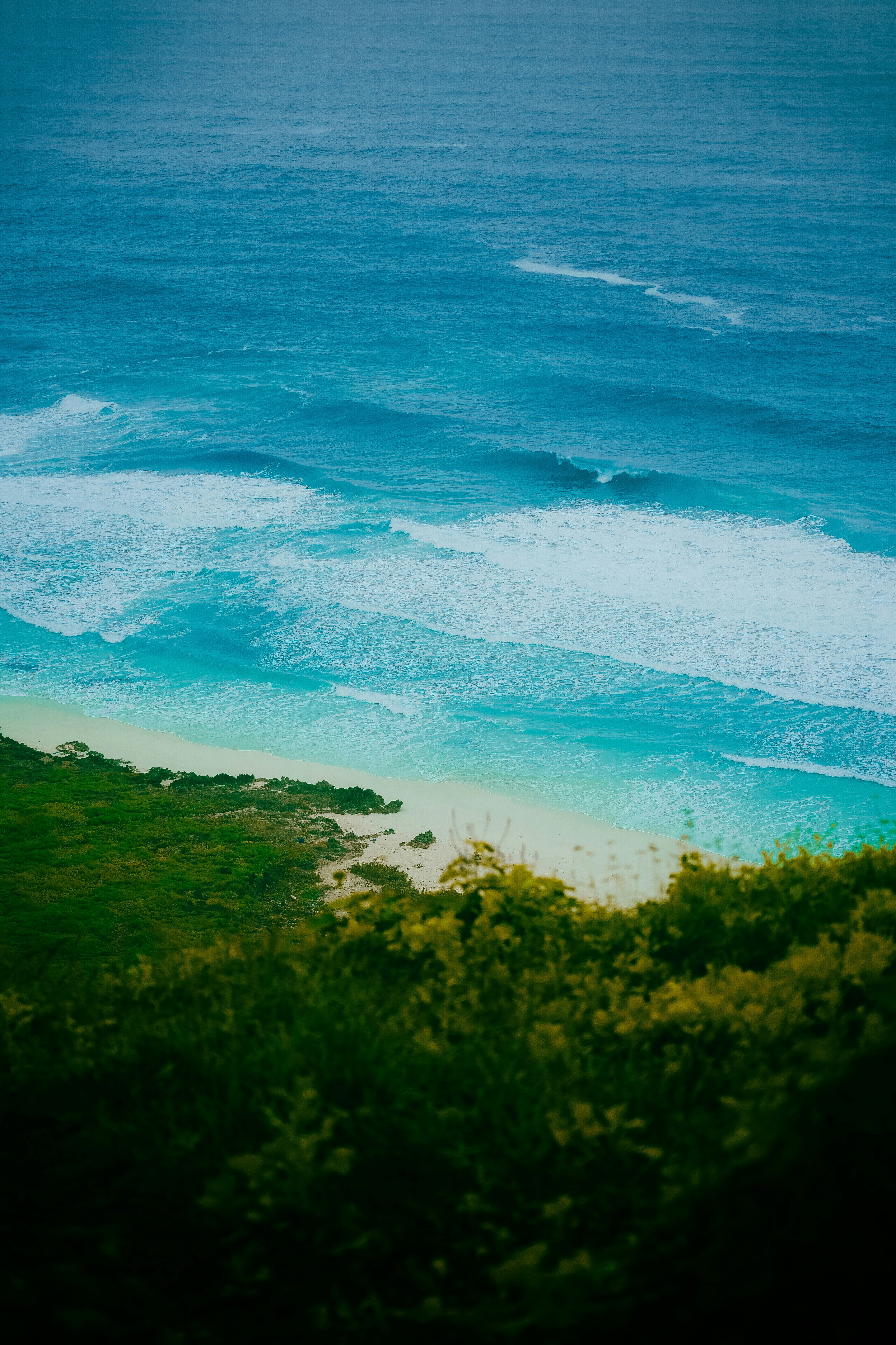Aegean Cliffside View: Turquoise Shoreline and Surfing Sea