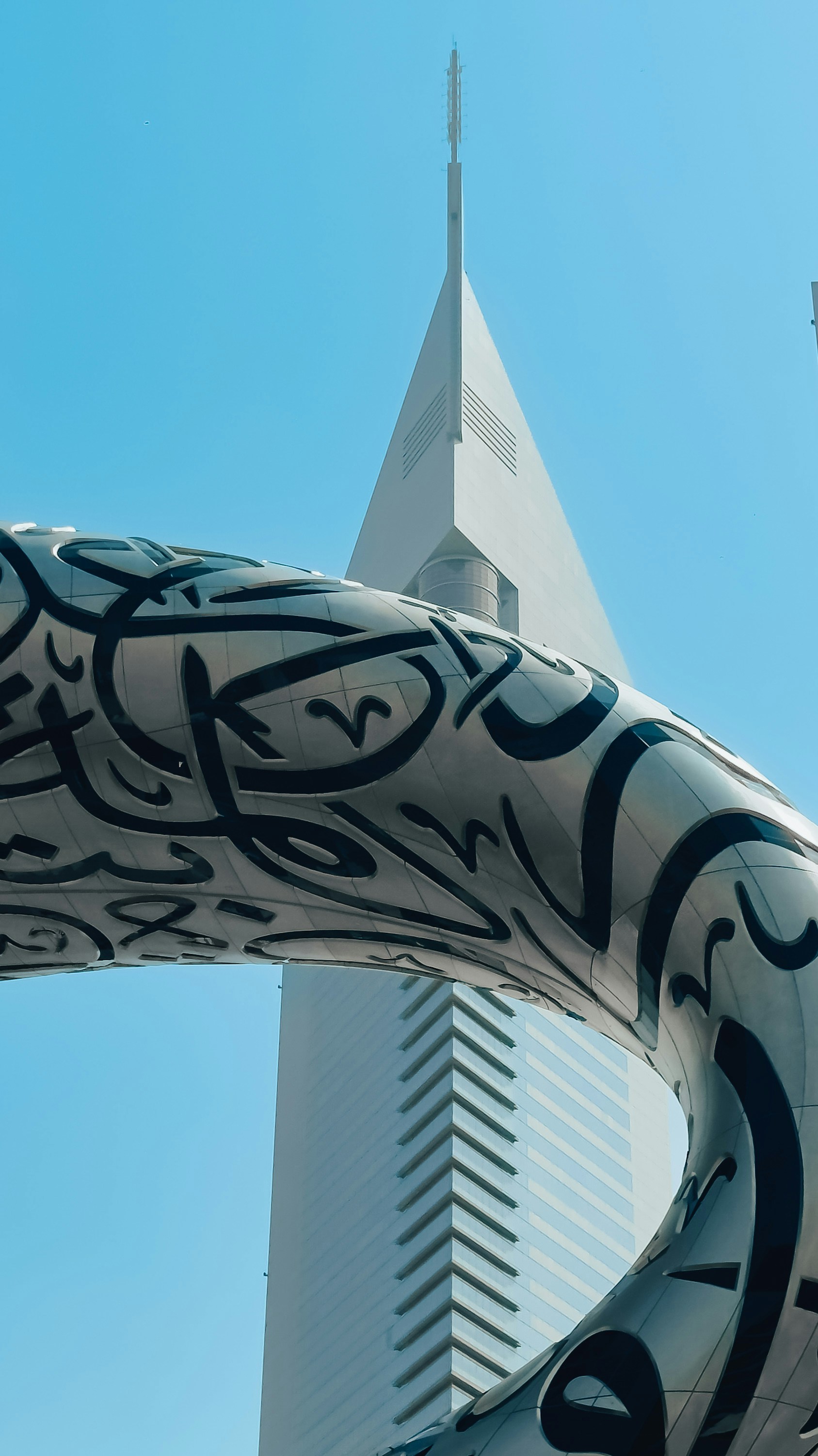 Arched Graffiti Ribbon Embracing a Towering Skyline