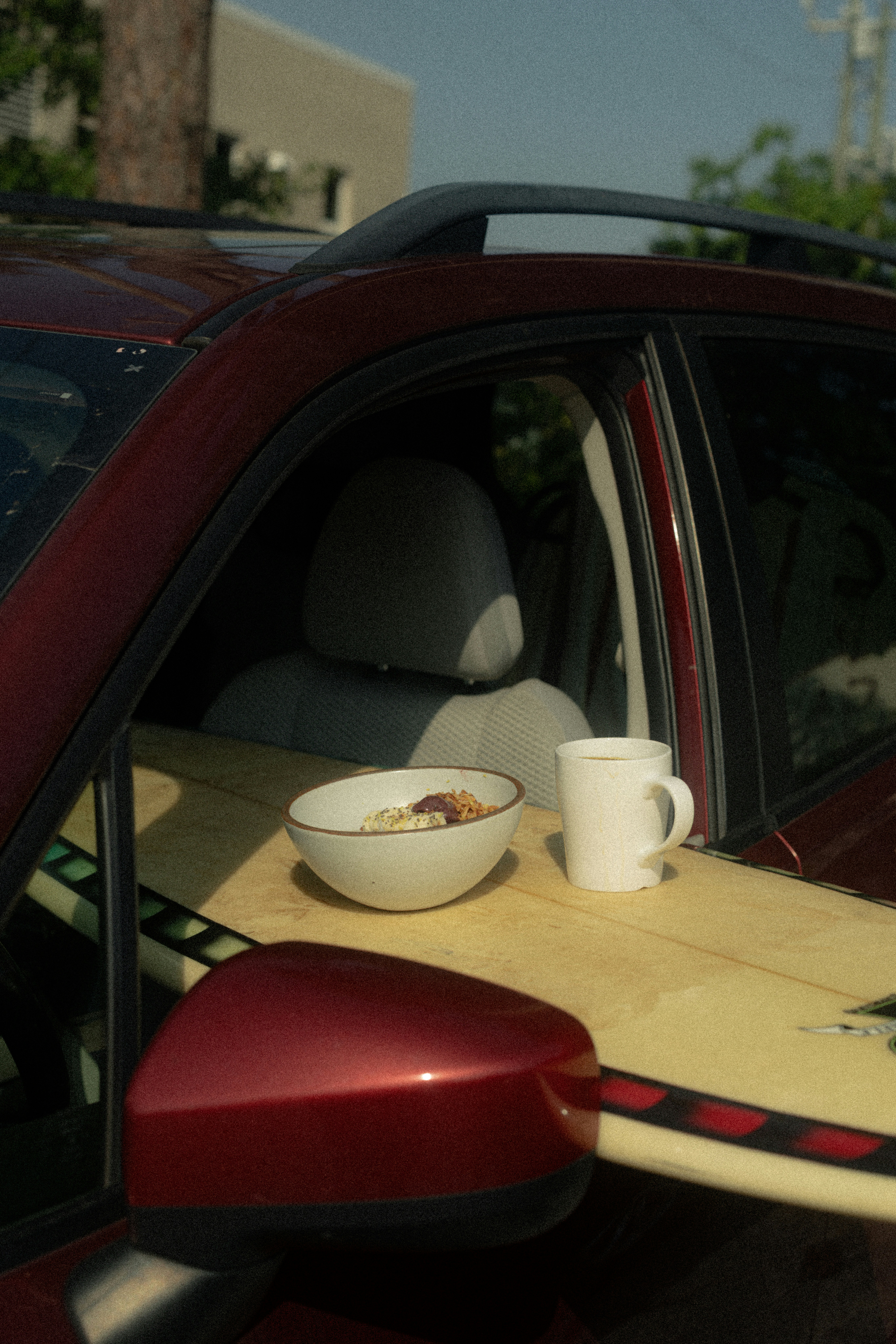 Car Cupboard: A Bowl, a Mug, and a Surfboard Across the Car Door