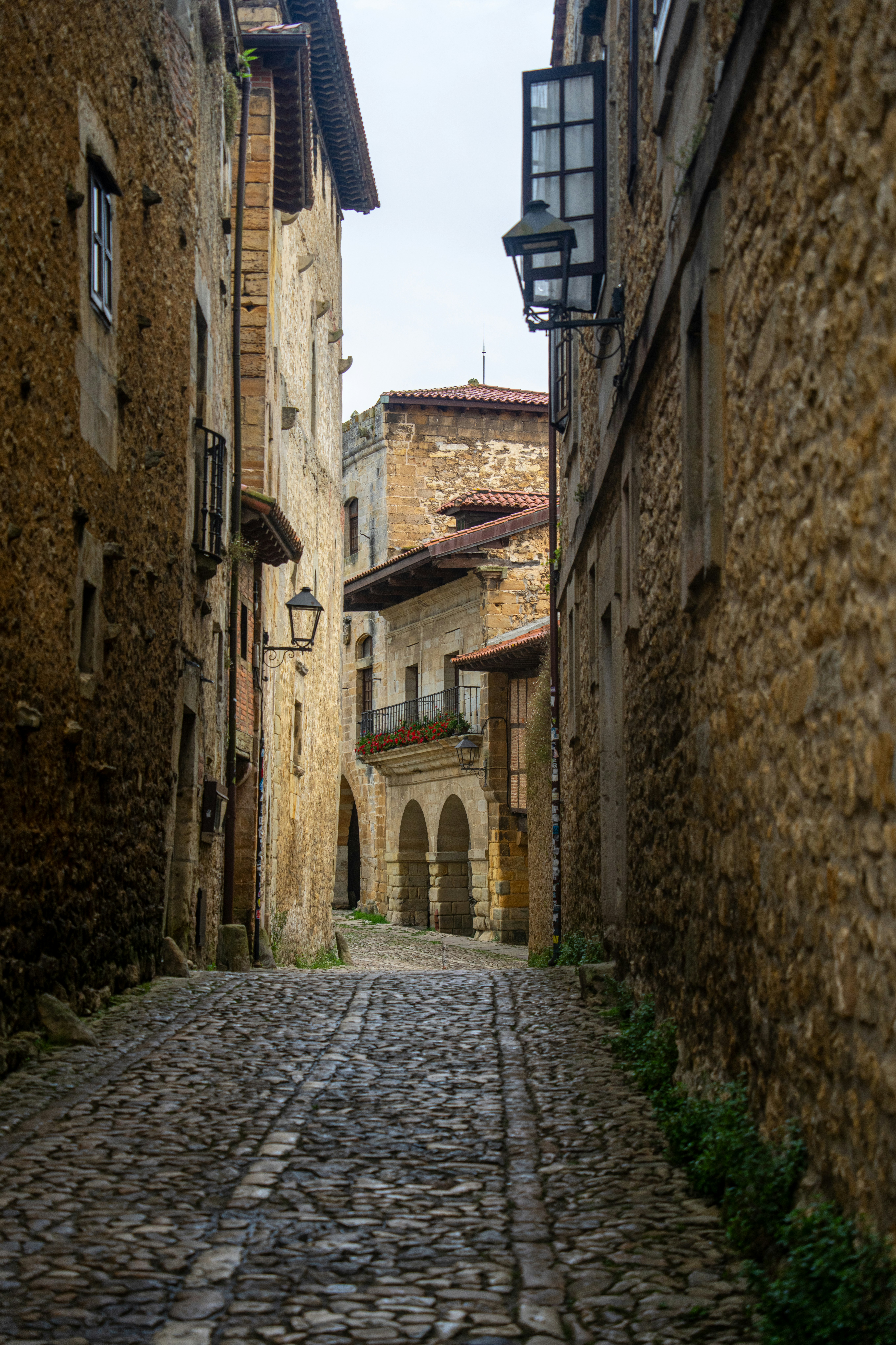 Cobbled Alleyway Portrait: Light Between Stone Walls