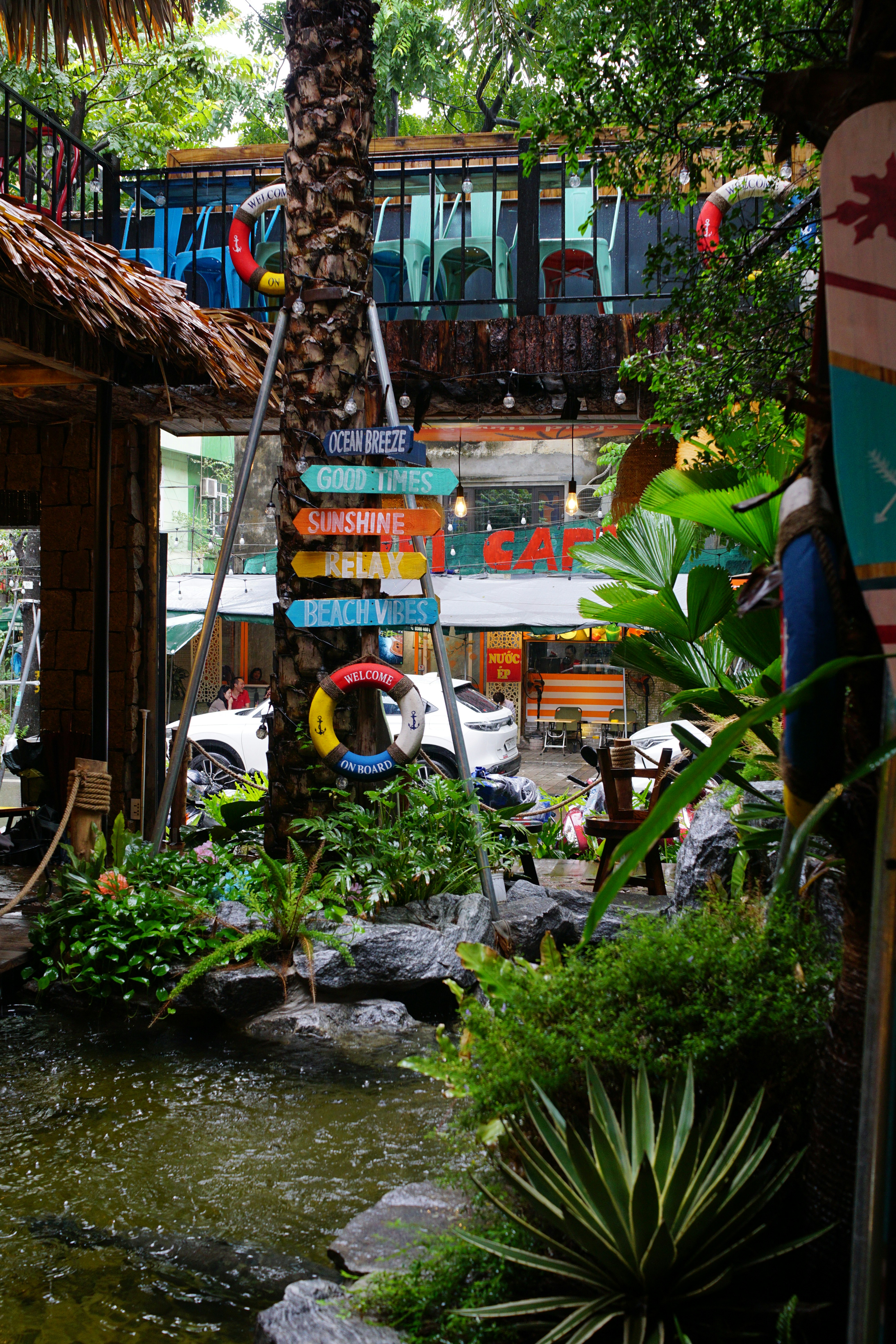 Colorful Beach Signpost Rests by a Tropical Poolside Nook
