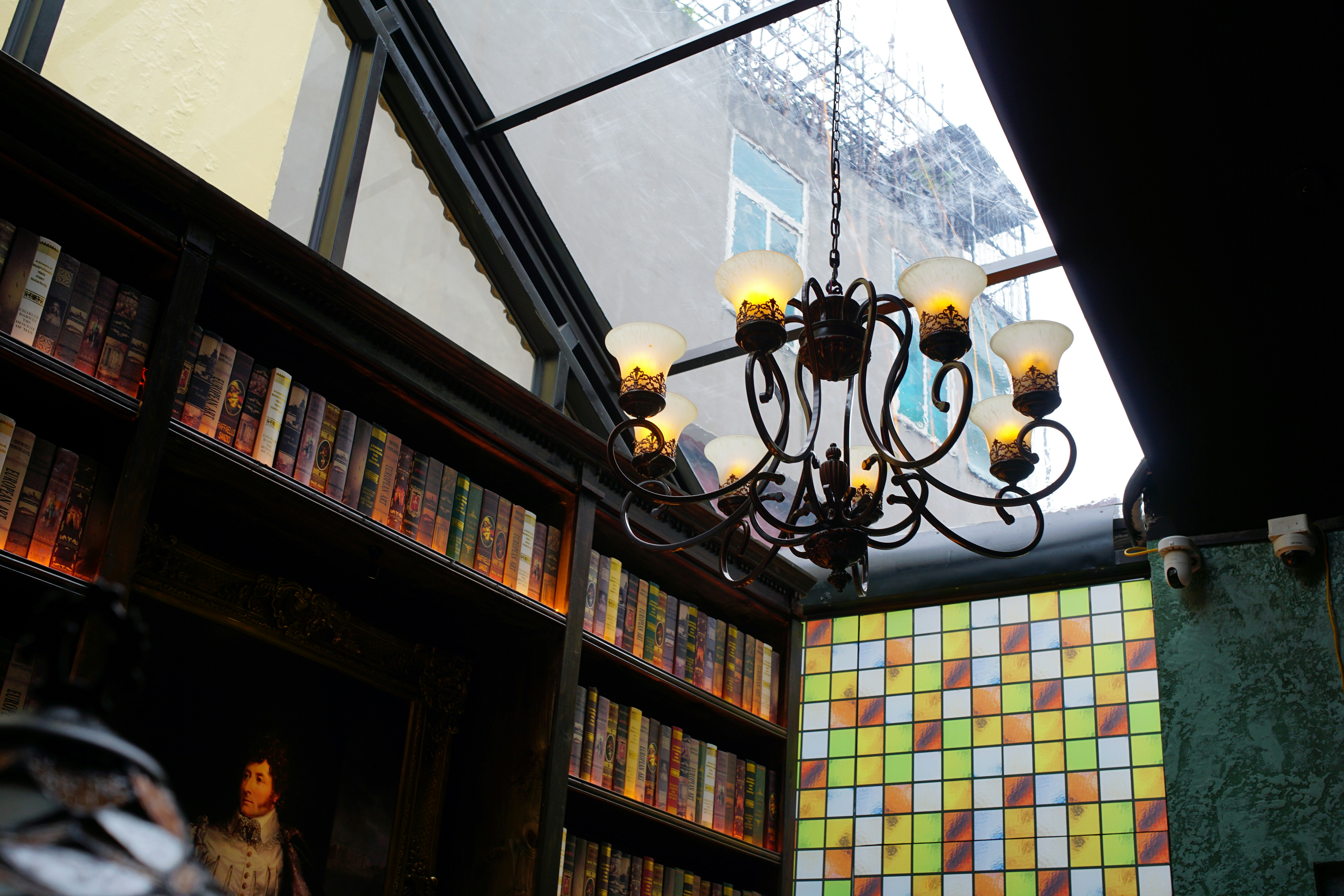 Chandelier Halo Over a Curated Library Corner