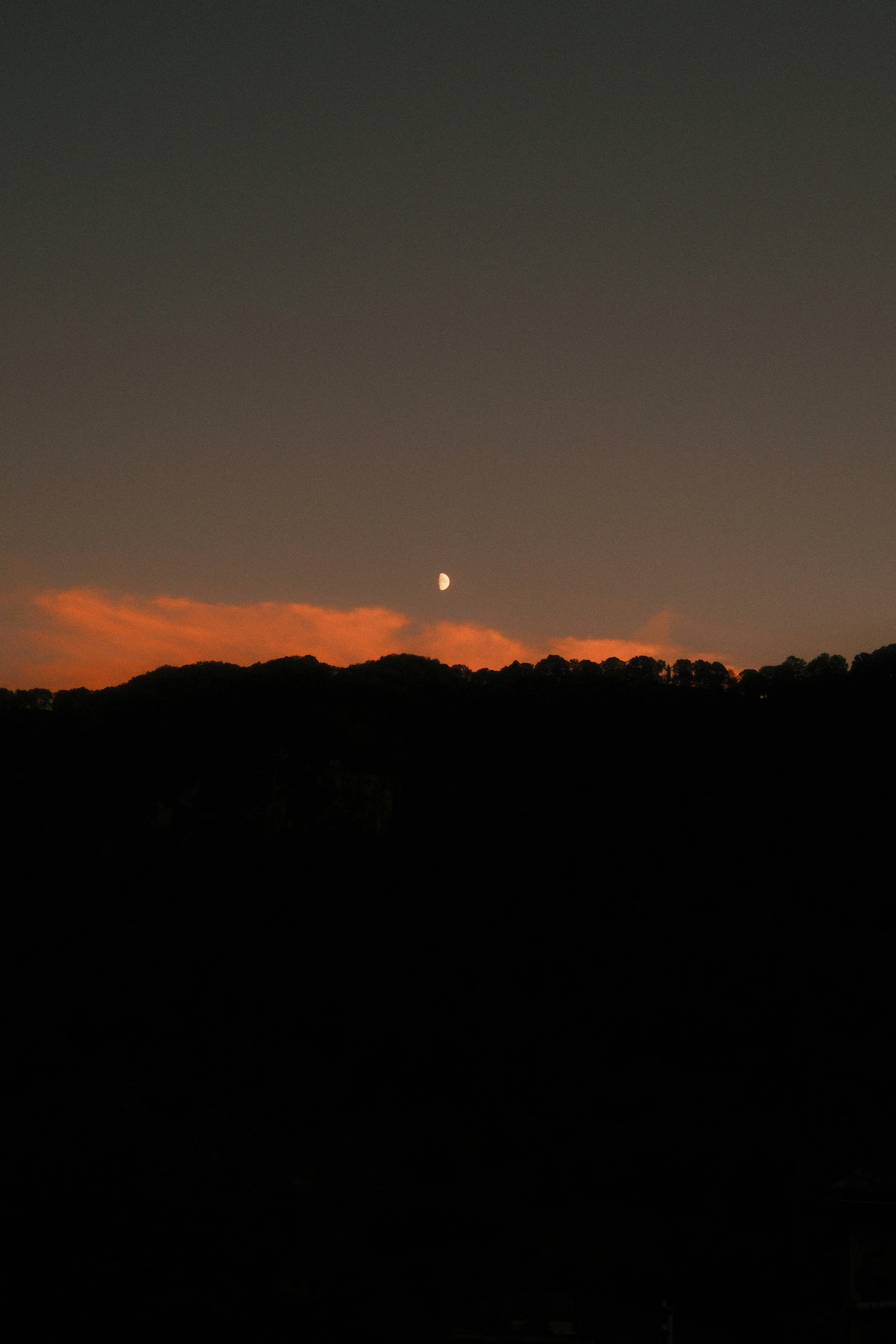 Dying embers Beyond the Horizon: The Moon over a Quiet Ridge