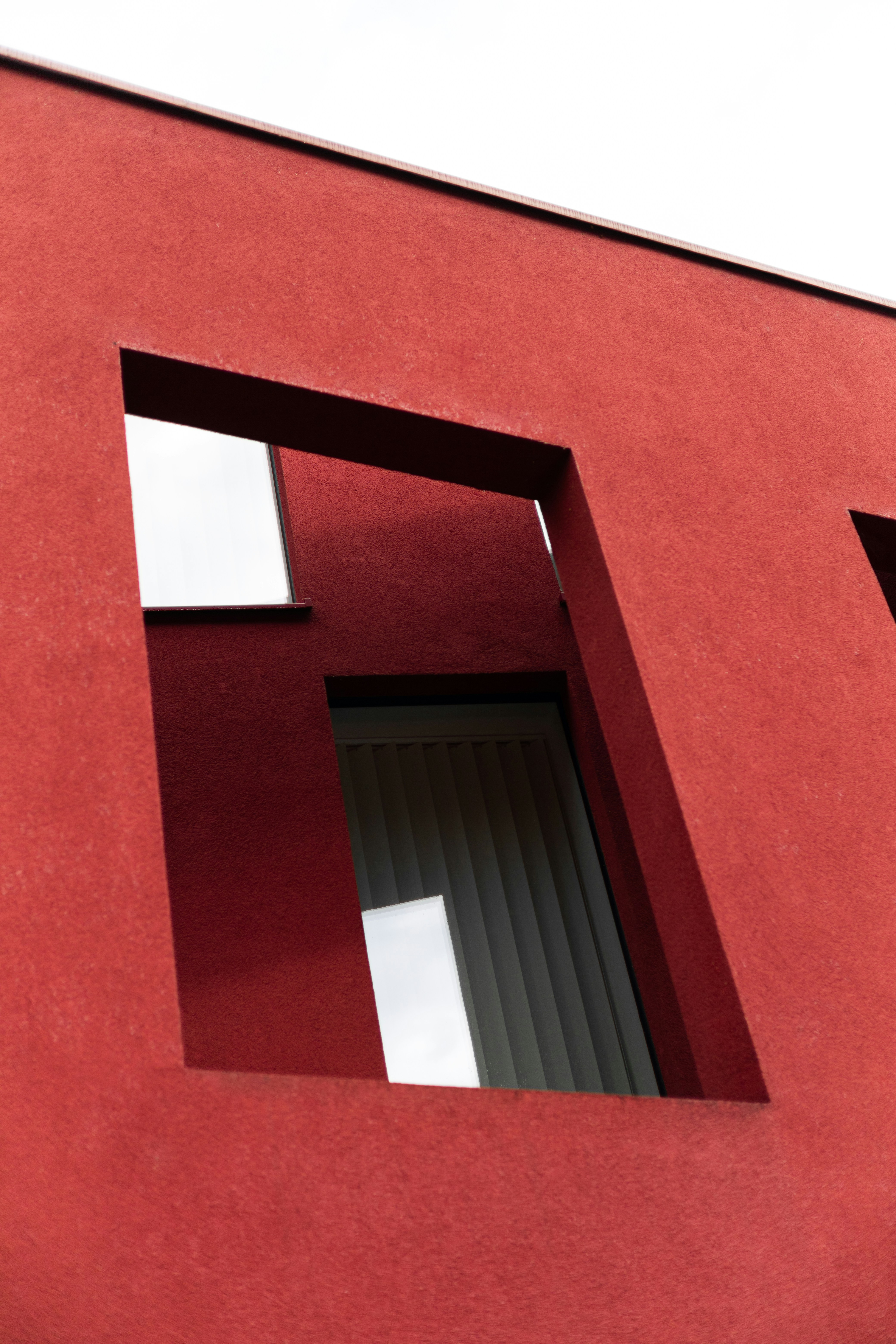Red Architectural Frame: A Tilted Window Portal in Sharp Focus