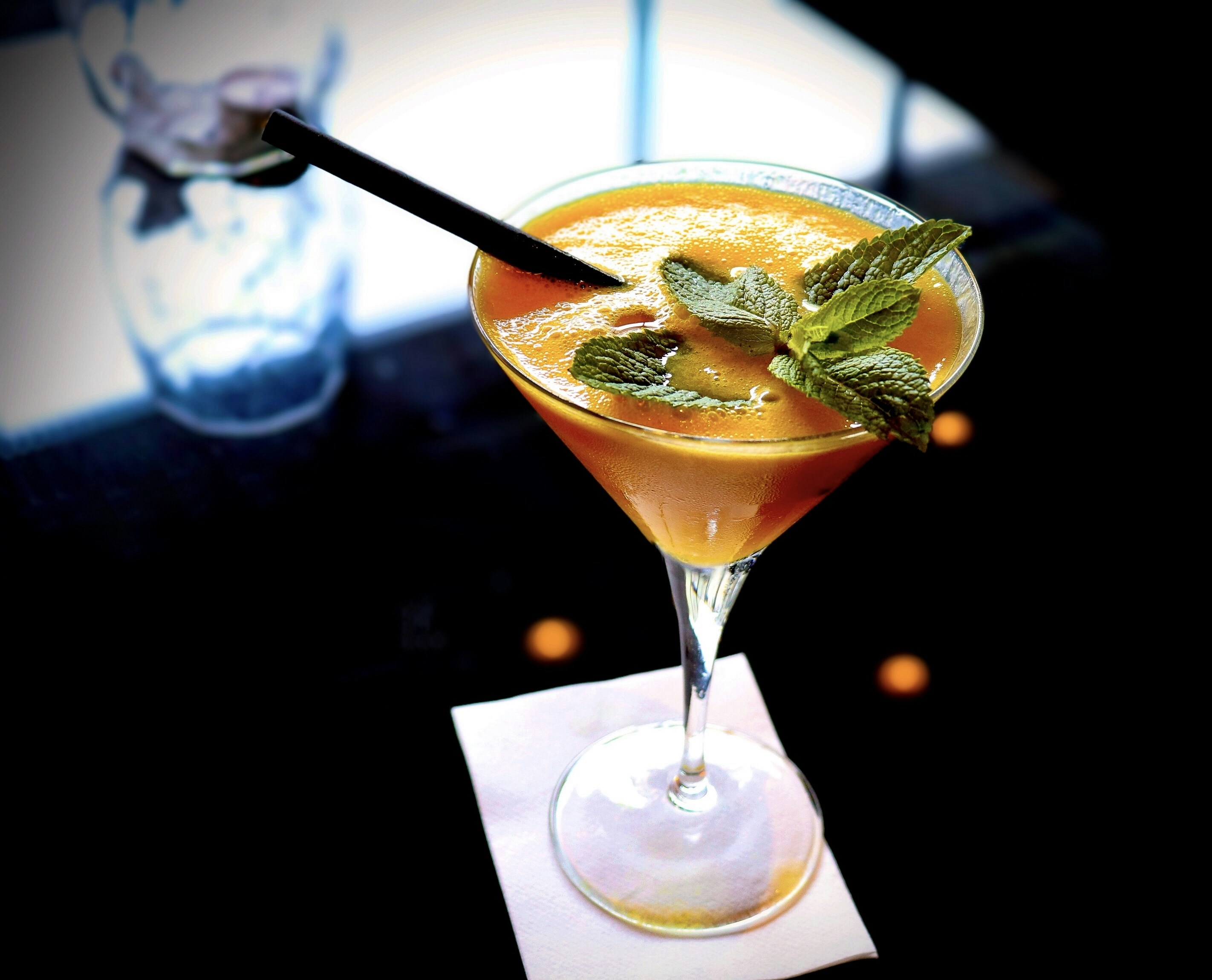 Amber Cocktail on a Glass Stem: A Sunset Splash in Focus