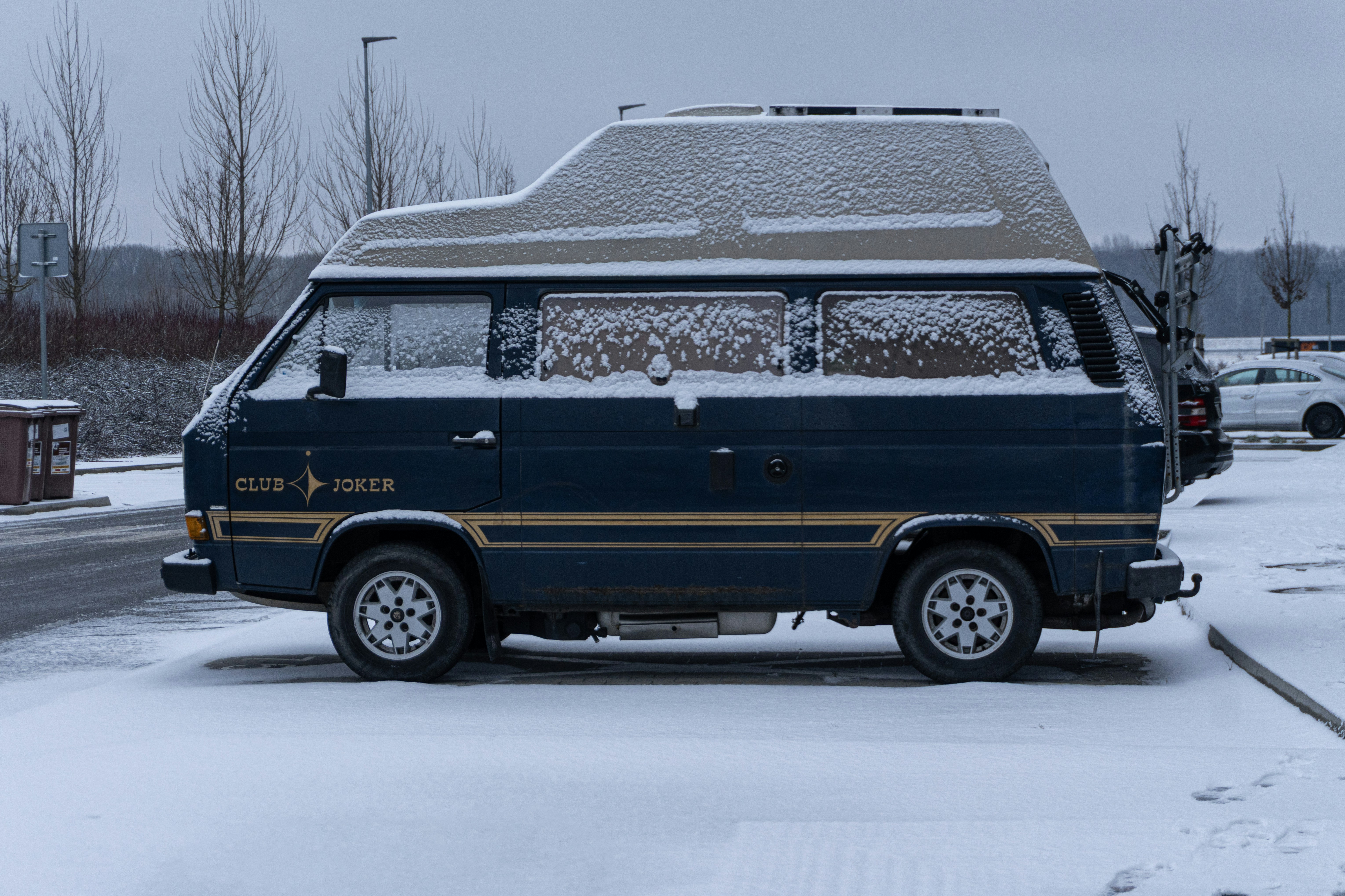 Snow-laced Road Warrior: A Classic Van in Winter Quiet