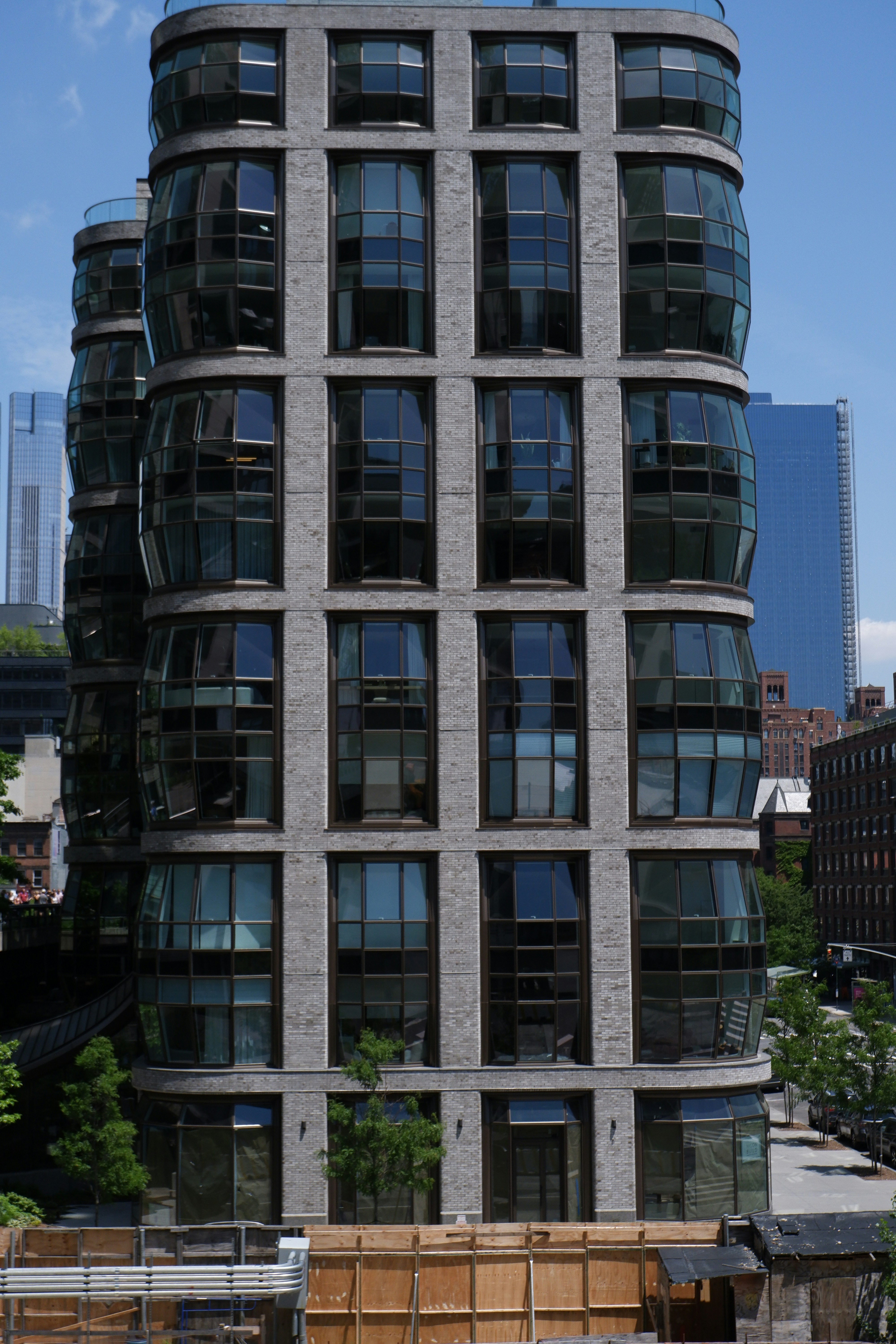 Towering Facade: Curved Glass and Brick in Urban Light