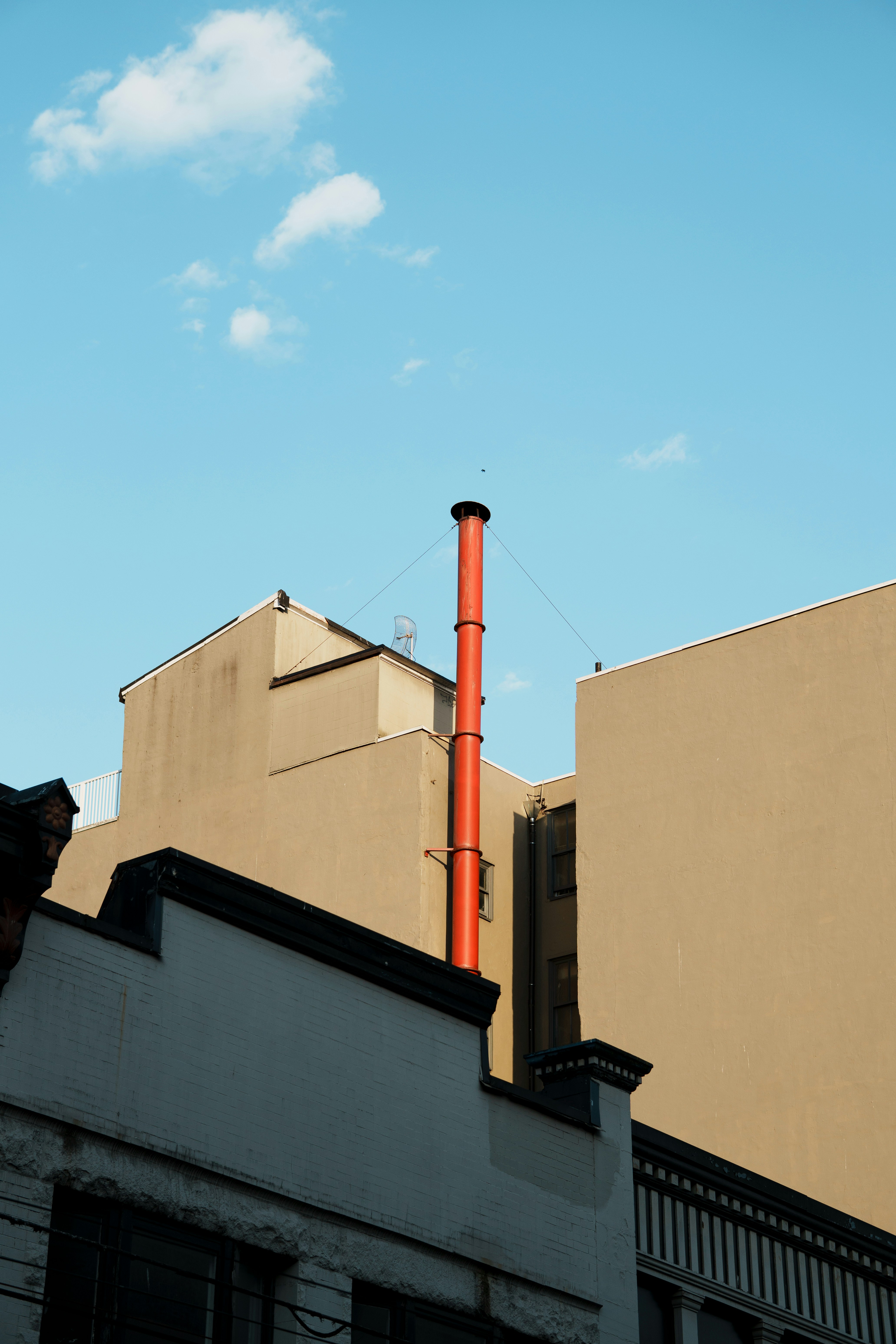 Red Chimney Rising Over City Walls