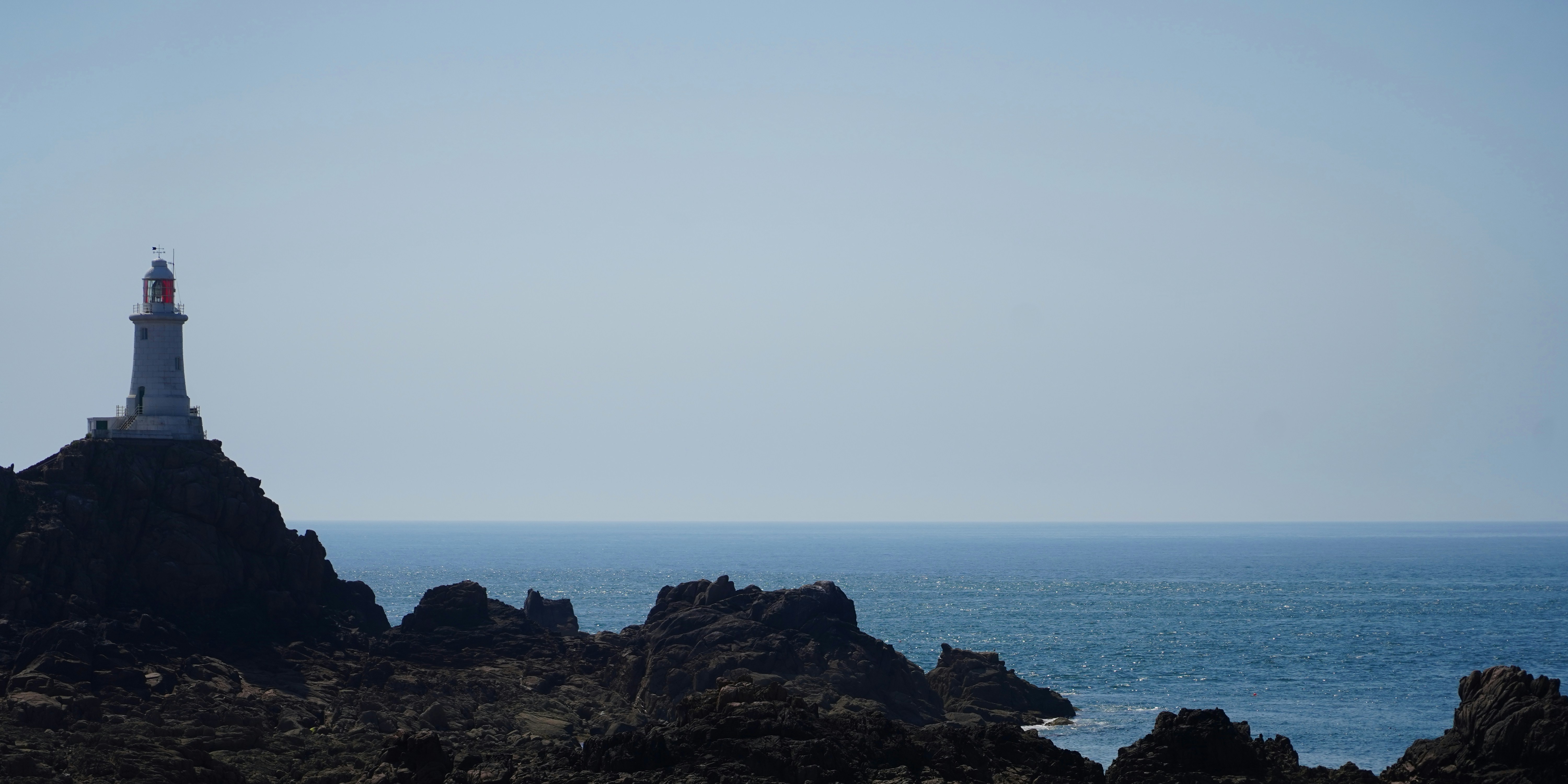 Lighthouse Sentinel: A Quiet Breakwater at Dusk