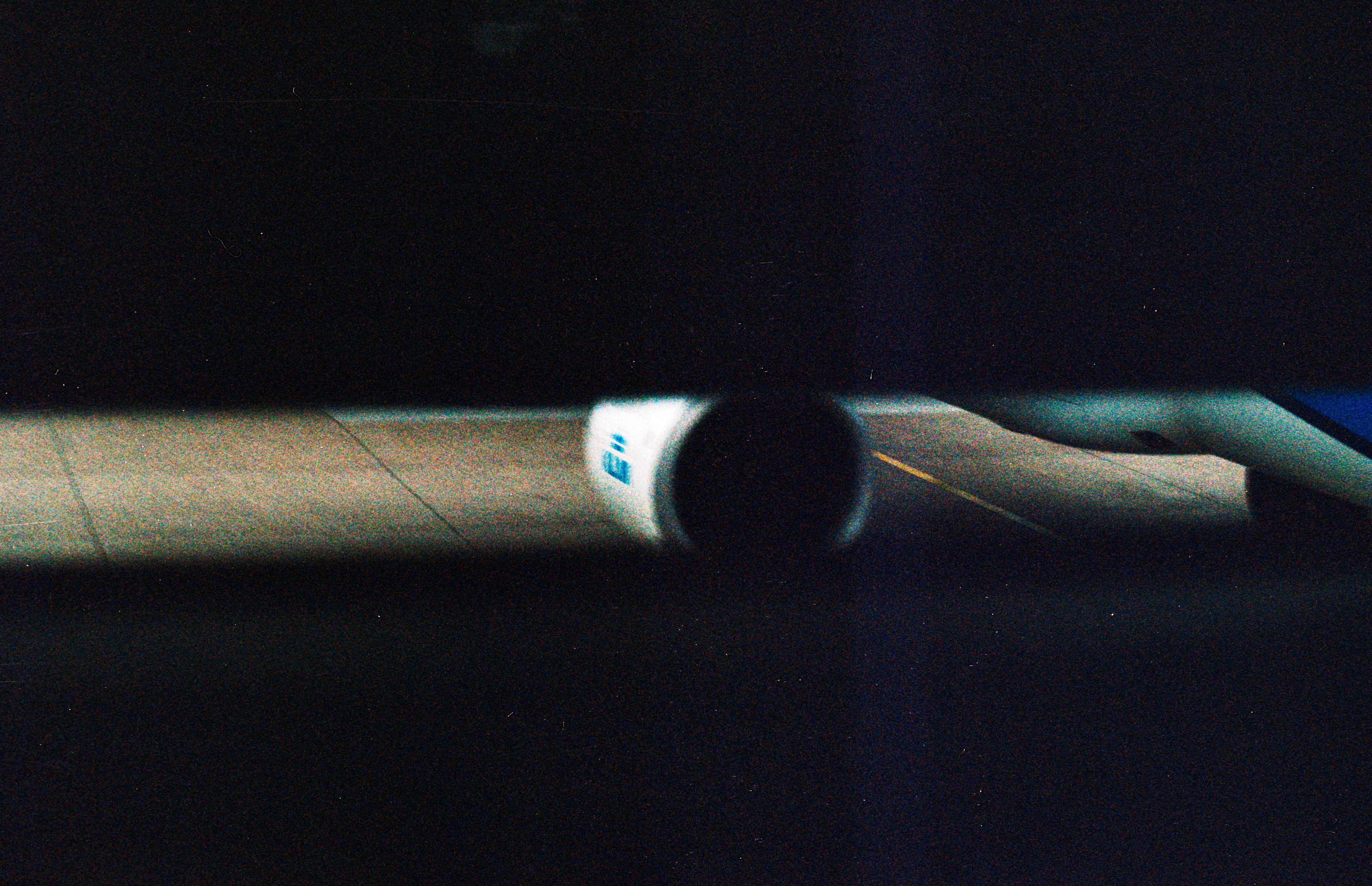 Low-Contrast Landing Gear Row: A Faint Engine Pierces the Shadow