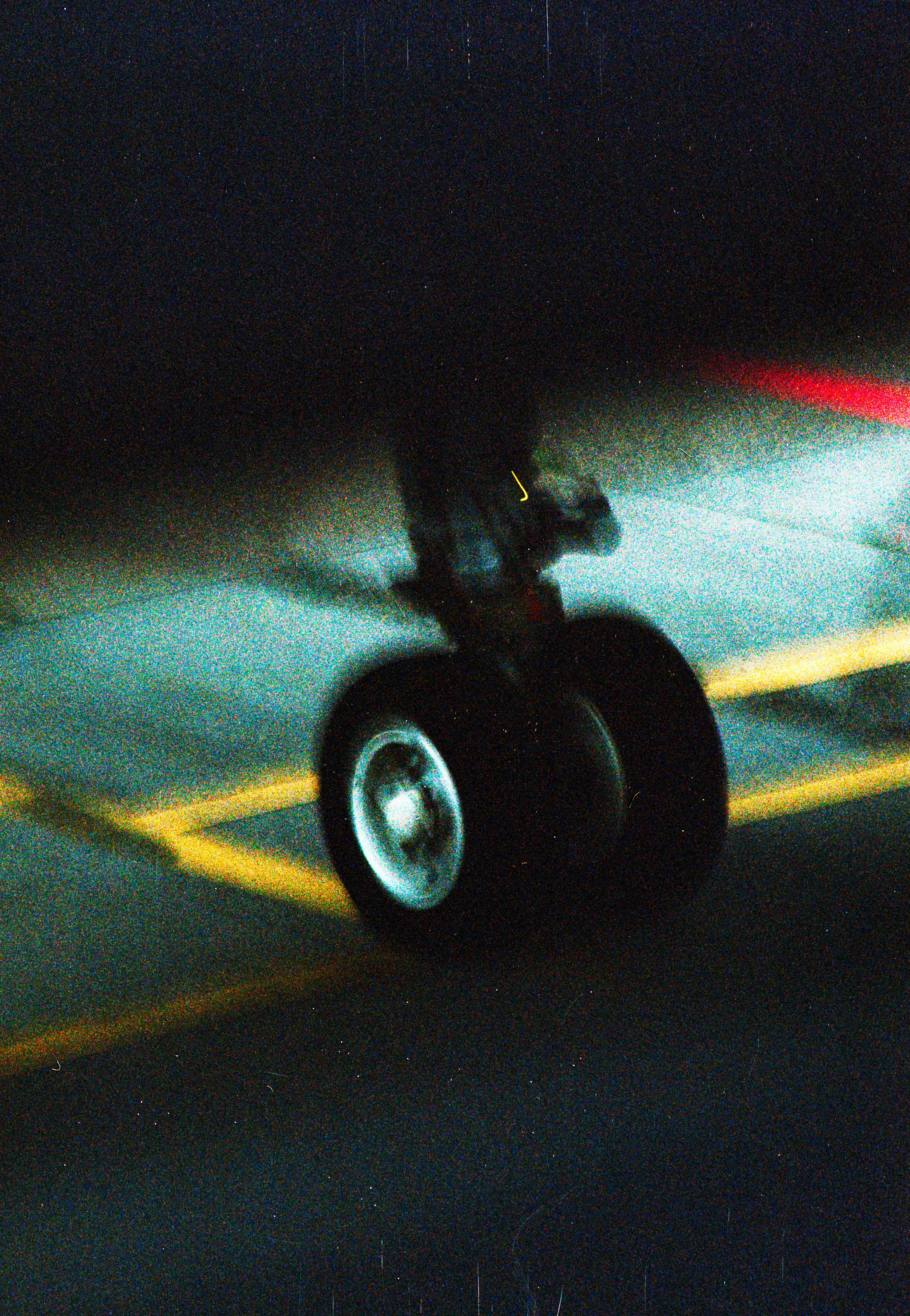 Night Runway in Motion: Blurred Wheel and Glowing Streaks