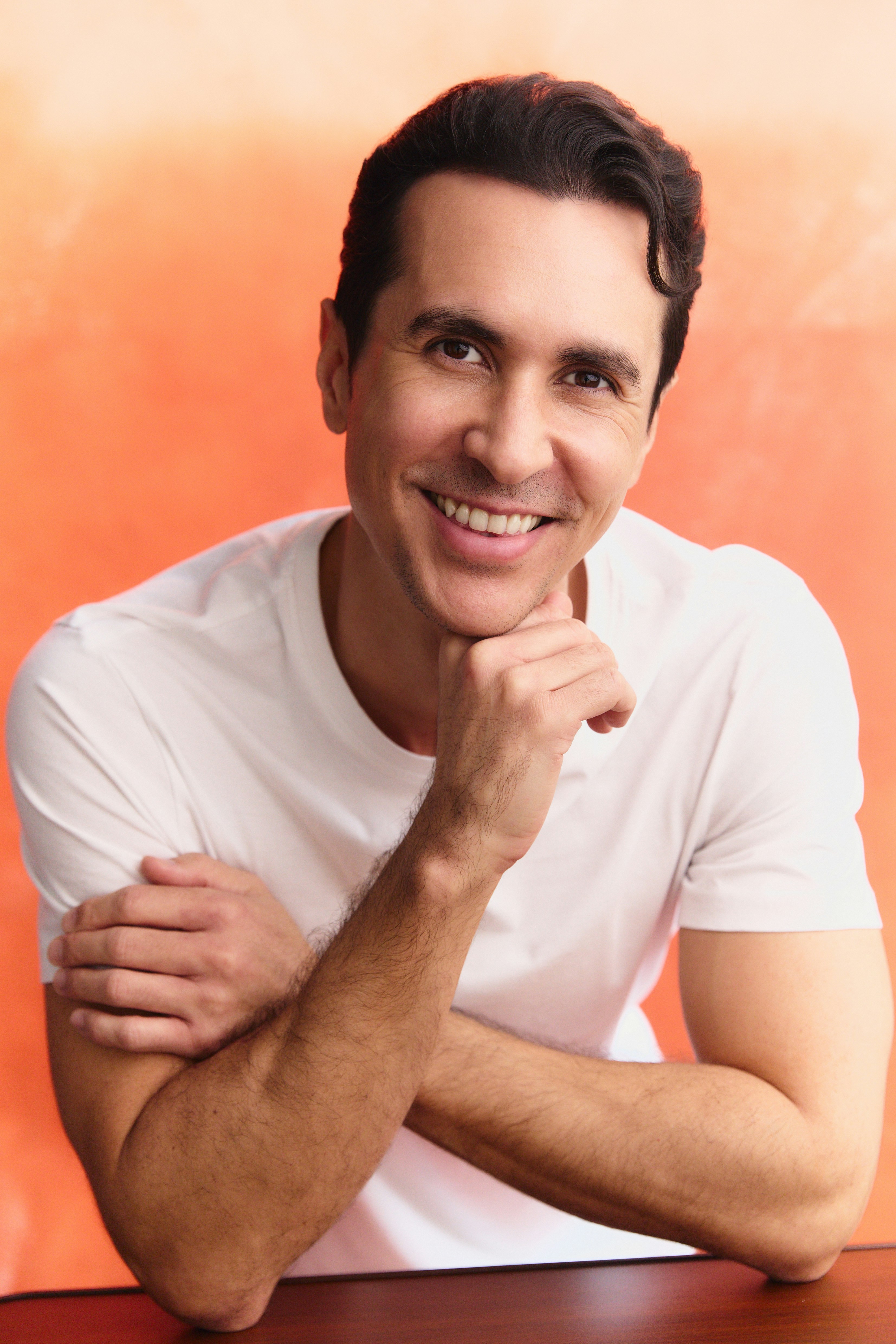 Warmposure: A Confident Smile Against Sunset Orange