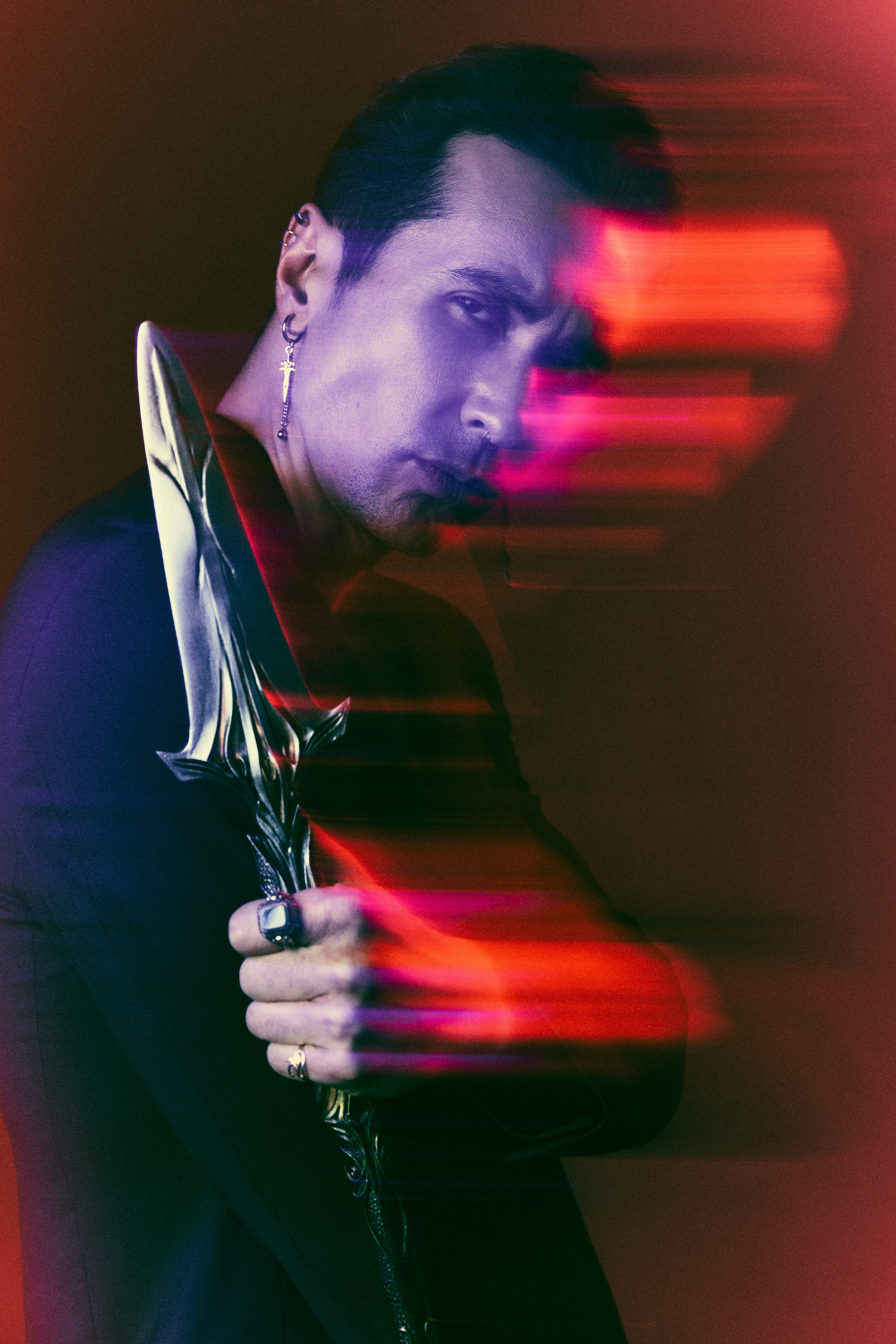 Crimson Echoes: A Portrait in Motion with a Metallic Blade