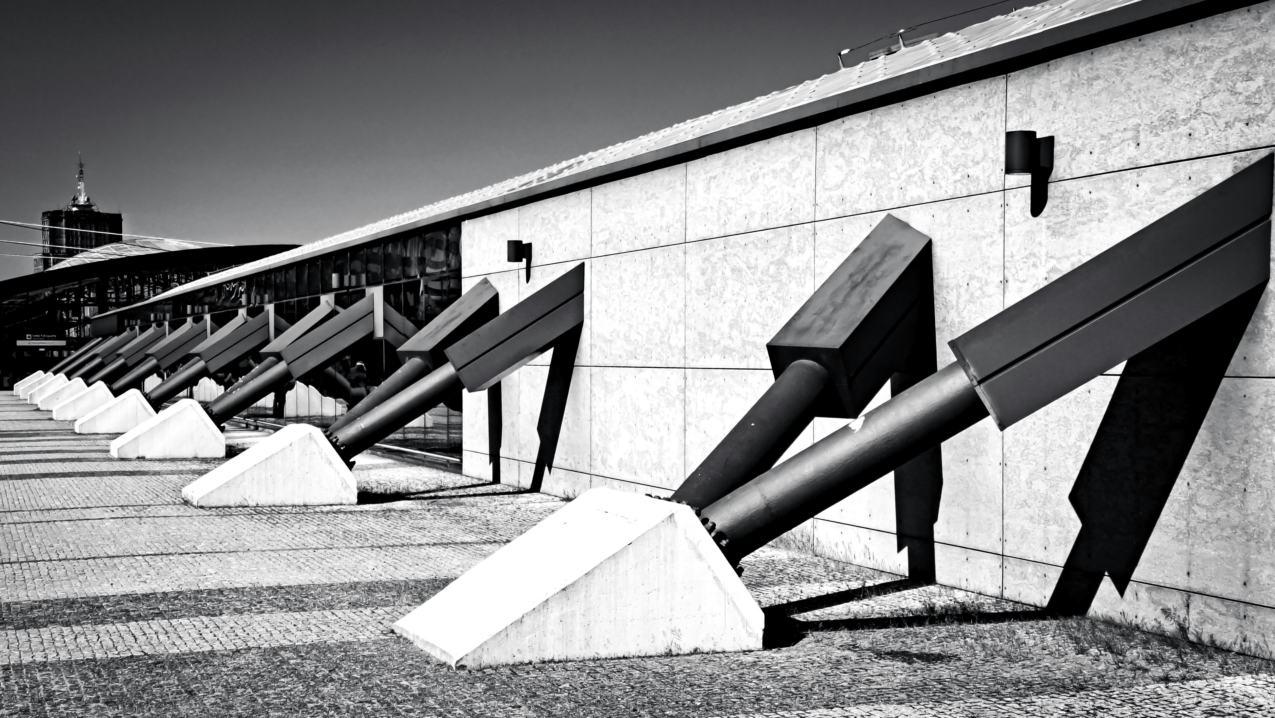 Chevron Shadows: A Row of Angled Barriers Cast in Monochrome