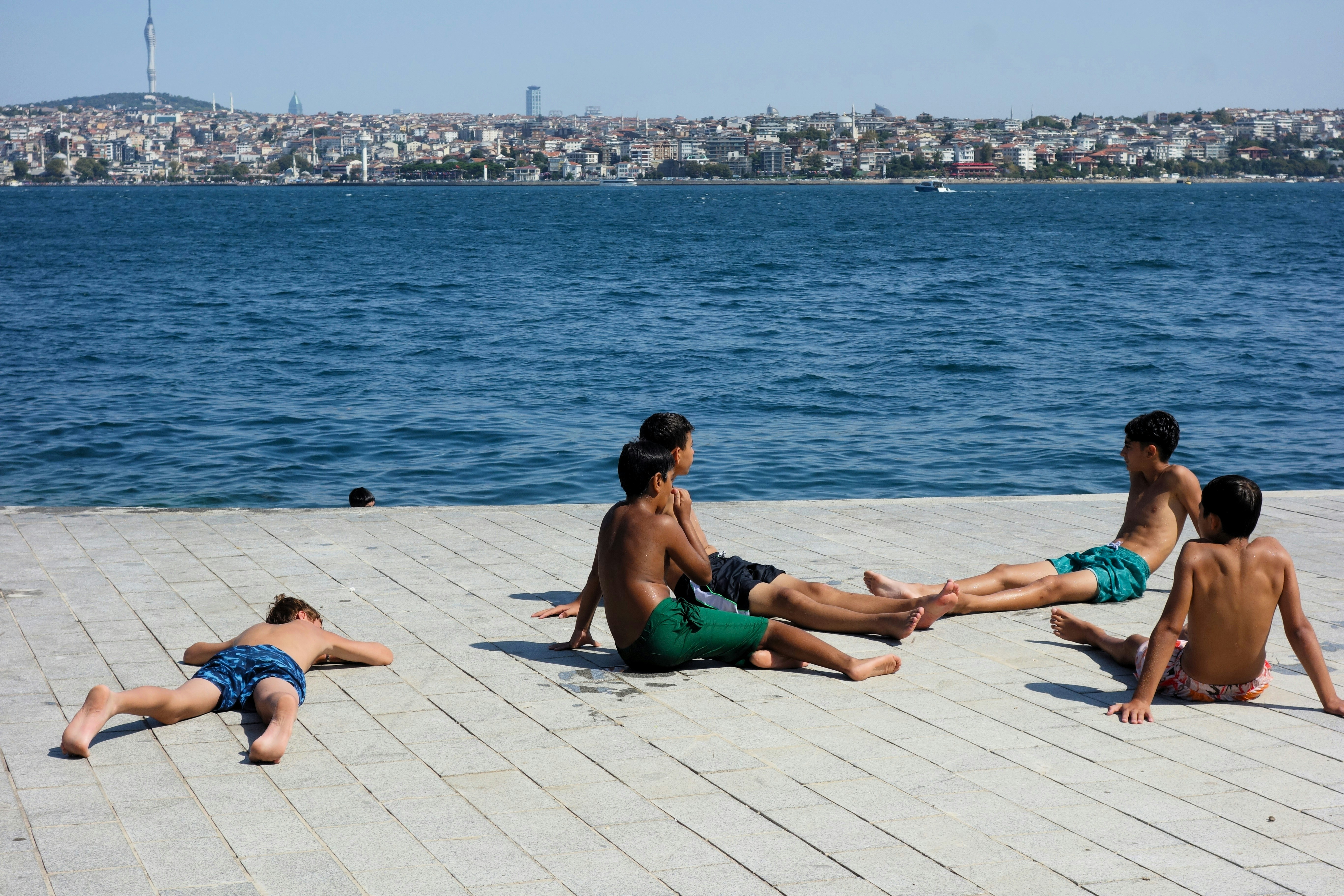 Sunlit Break by the Sea: A Casual Moment on the Pier