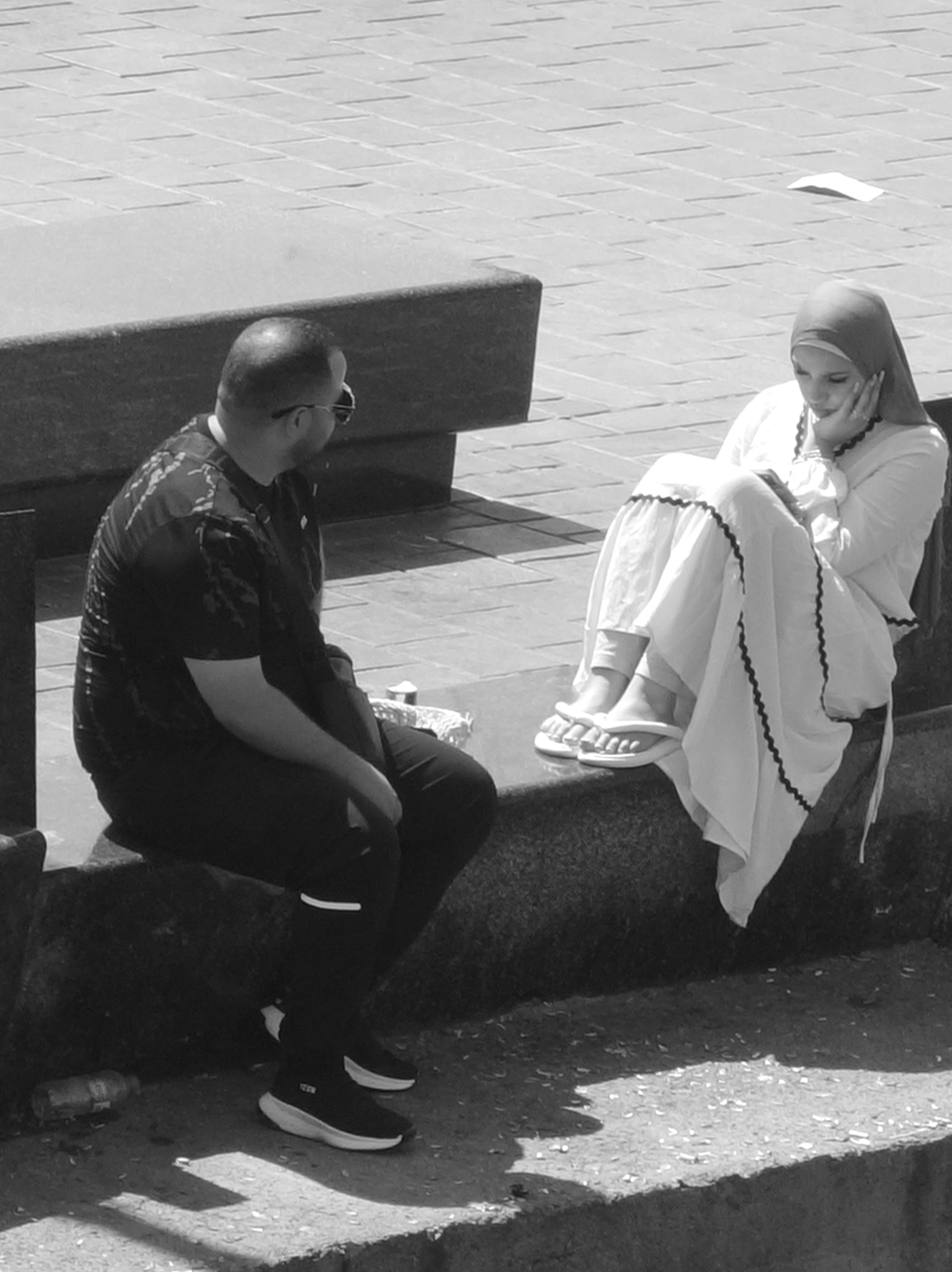 Two Strangers in Quiet Converse on a City Bench