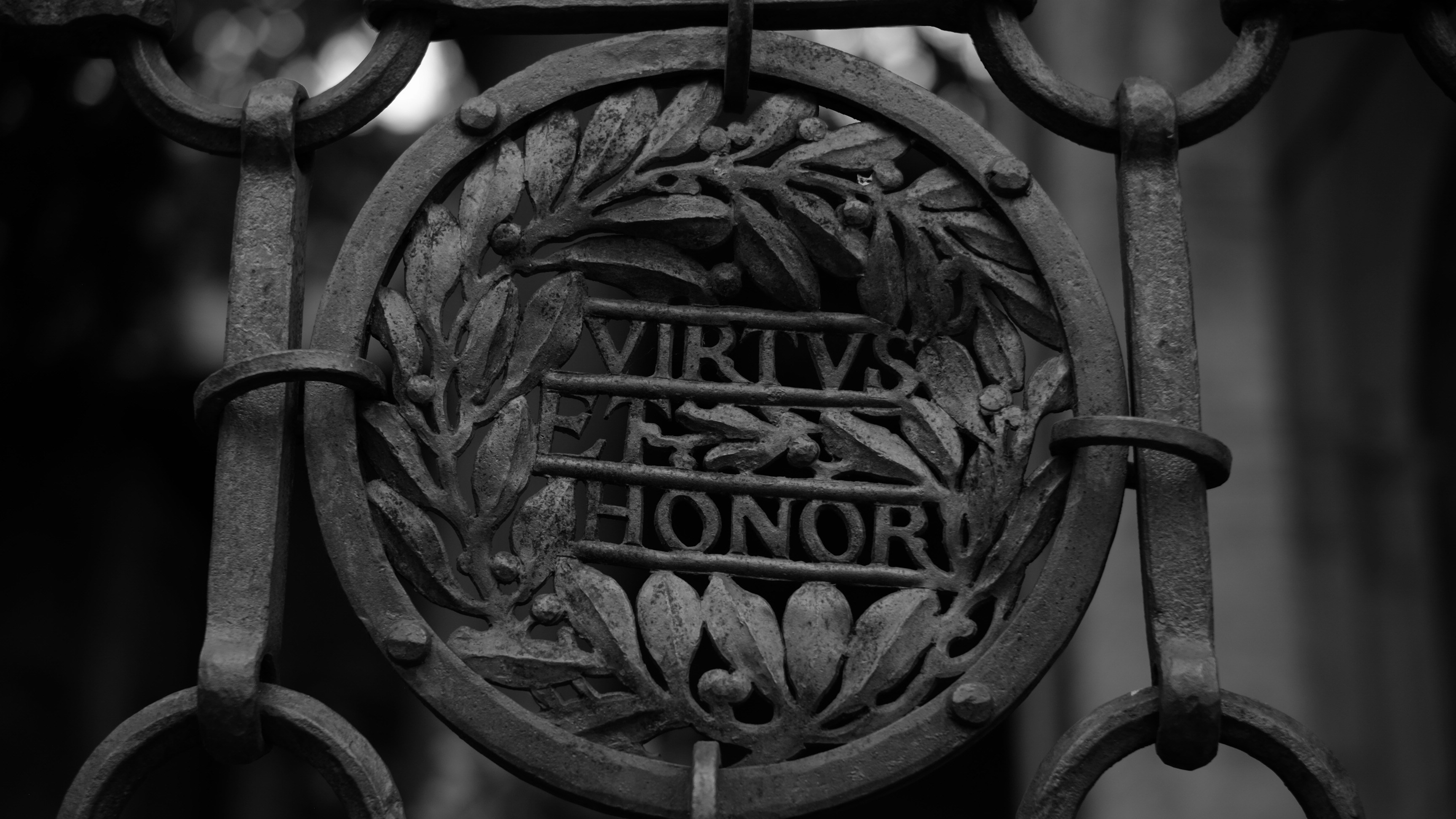 Emblem in Iron: Wreath and Inscription Behind Bars