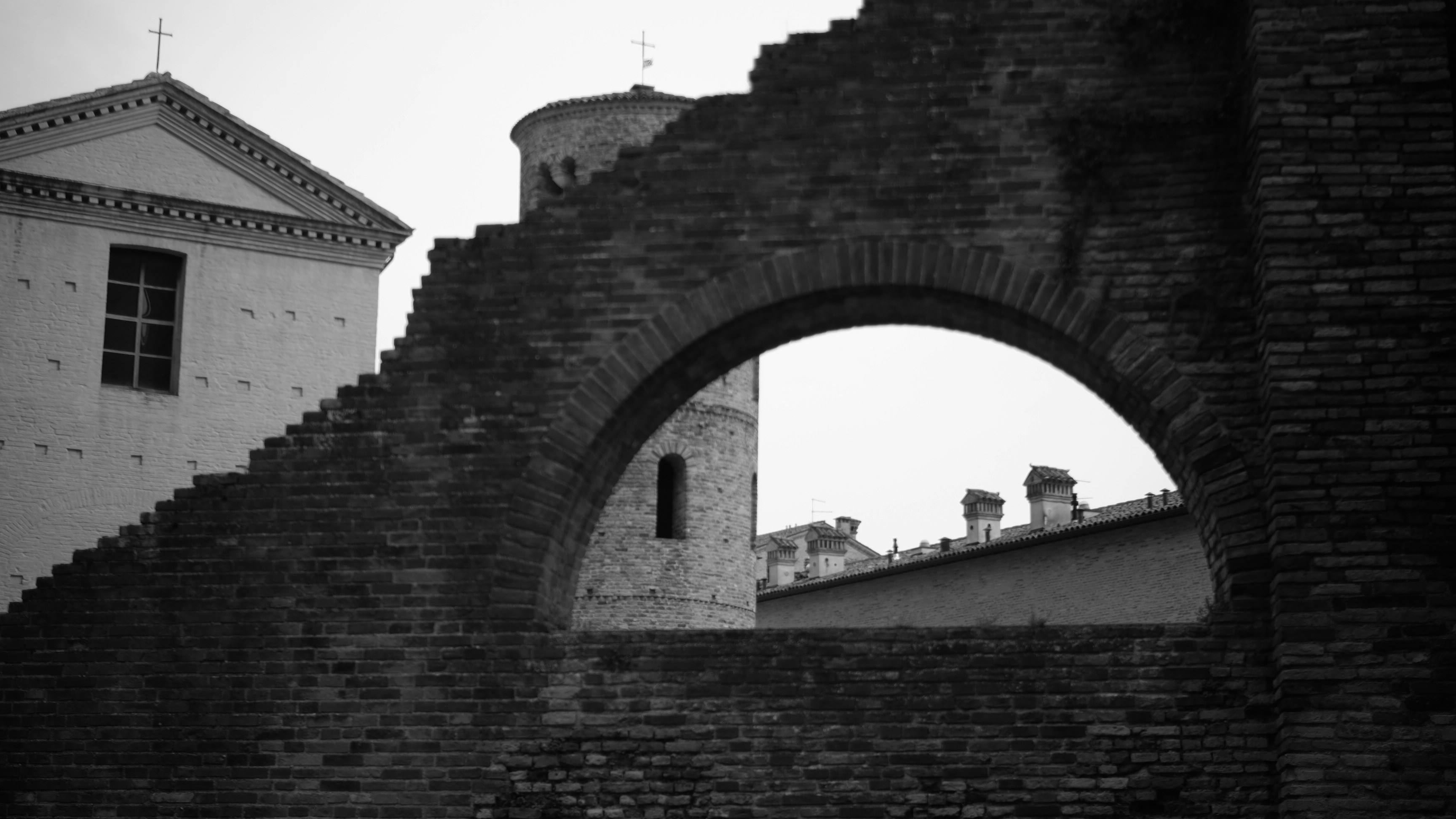 Archway Vista: Quiet Bricks and Sky Above a Ruined Gate