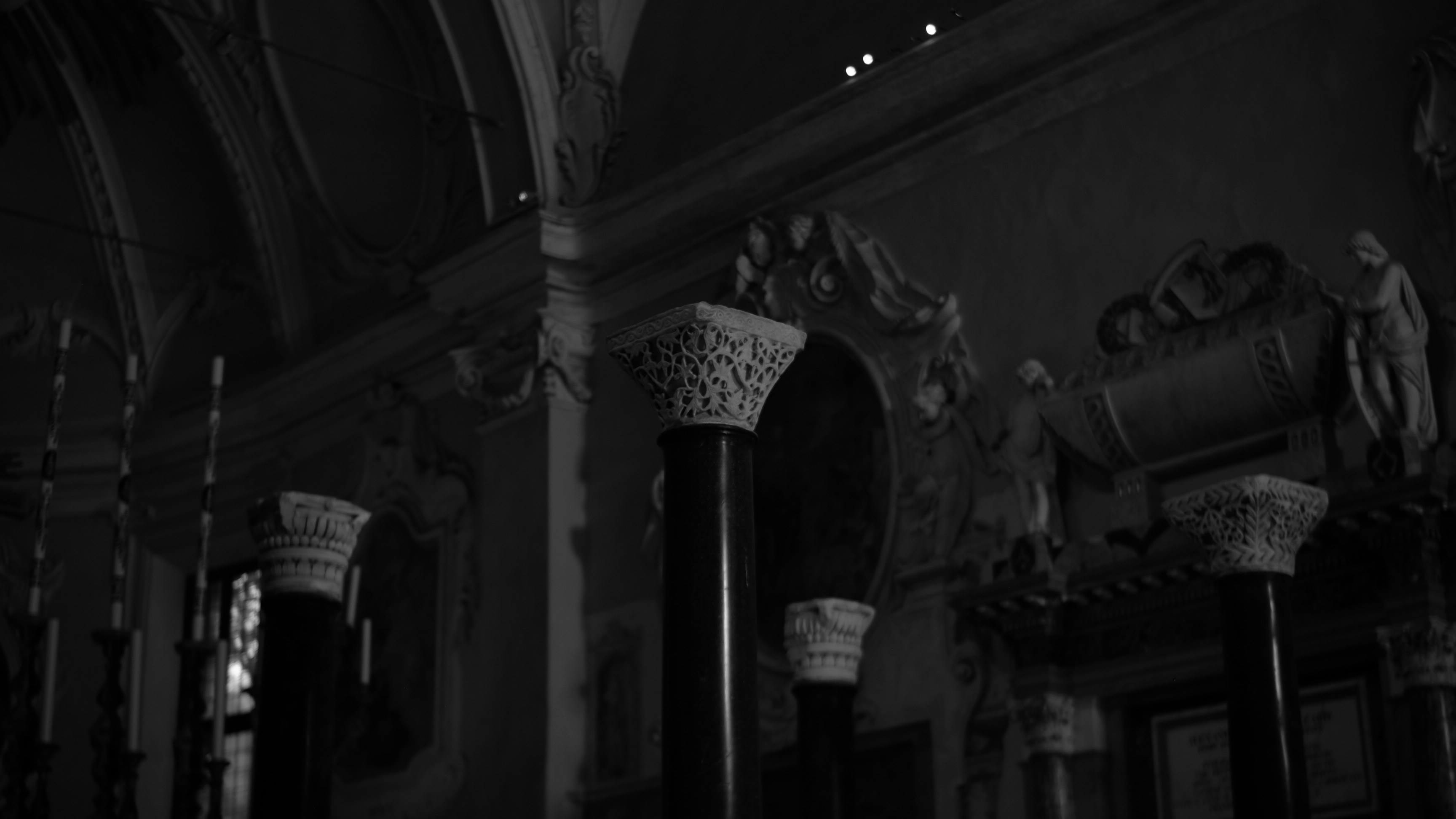 Gothic Interior: Pillars and Sculpted Altar Enveloped in Shadow