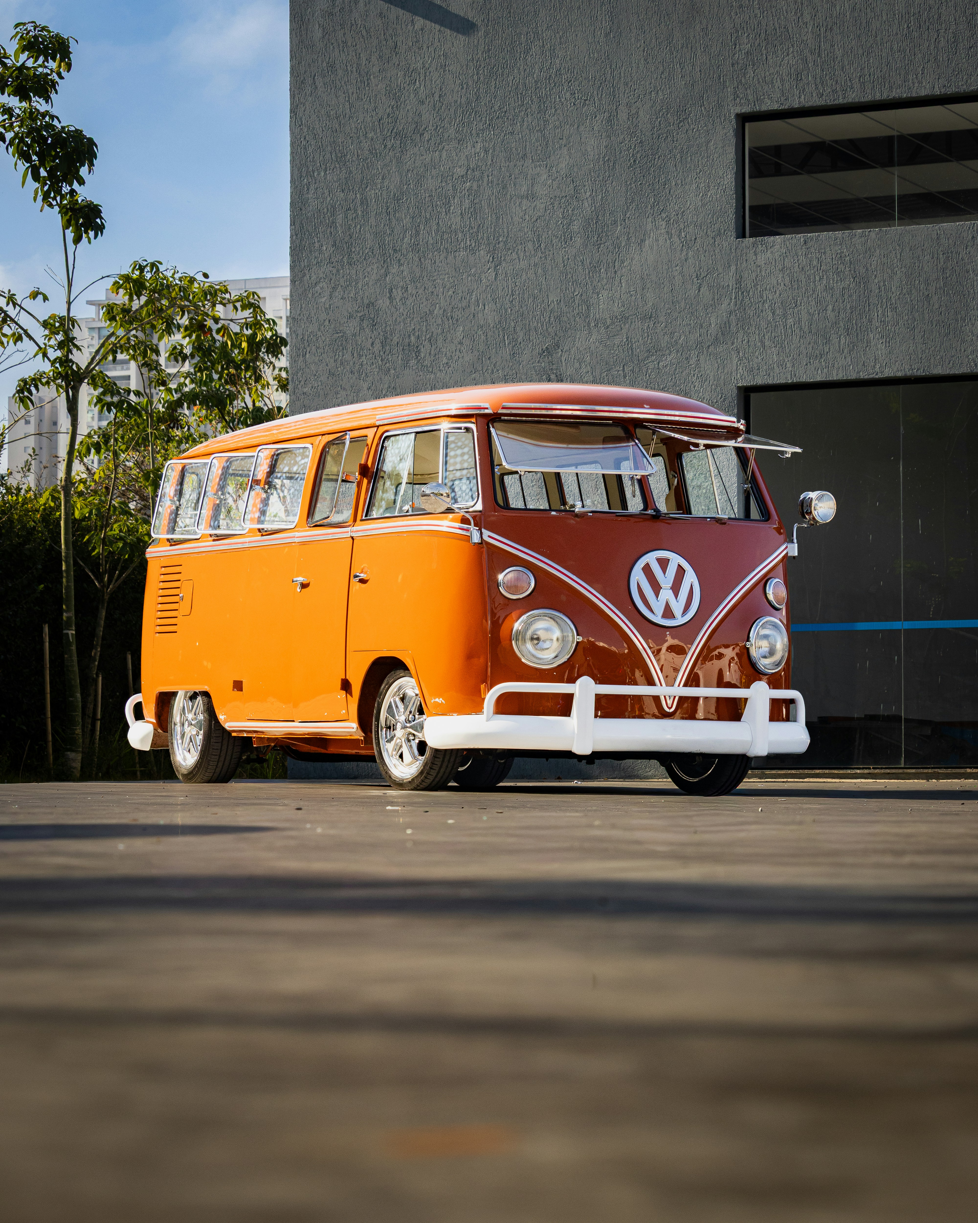 Orange VW Shuttle in Front of Modern Facade