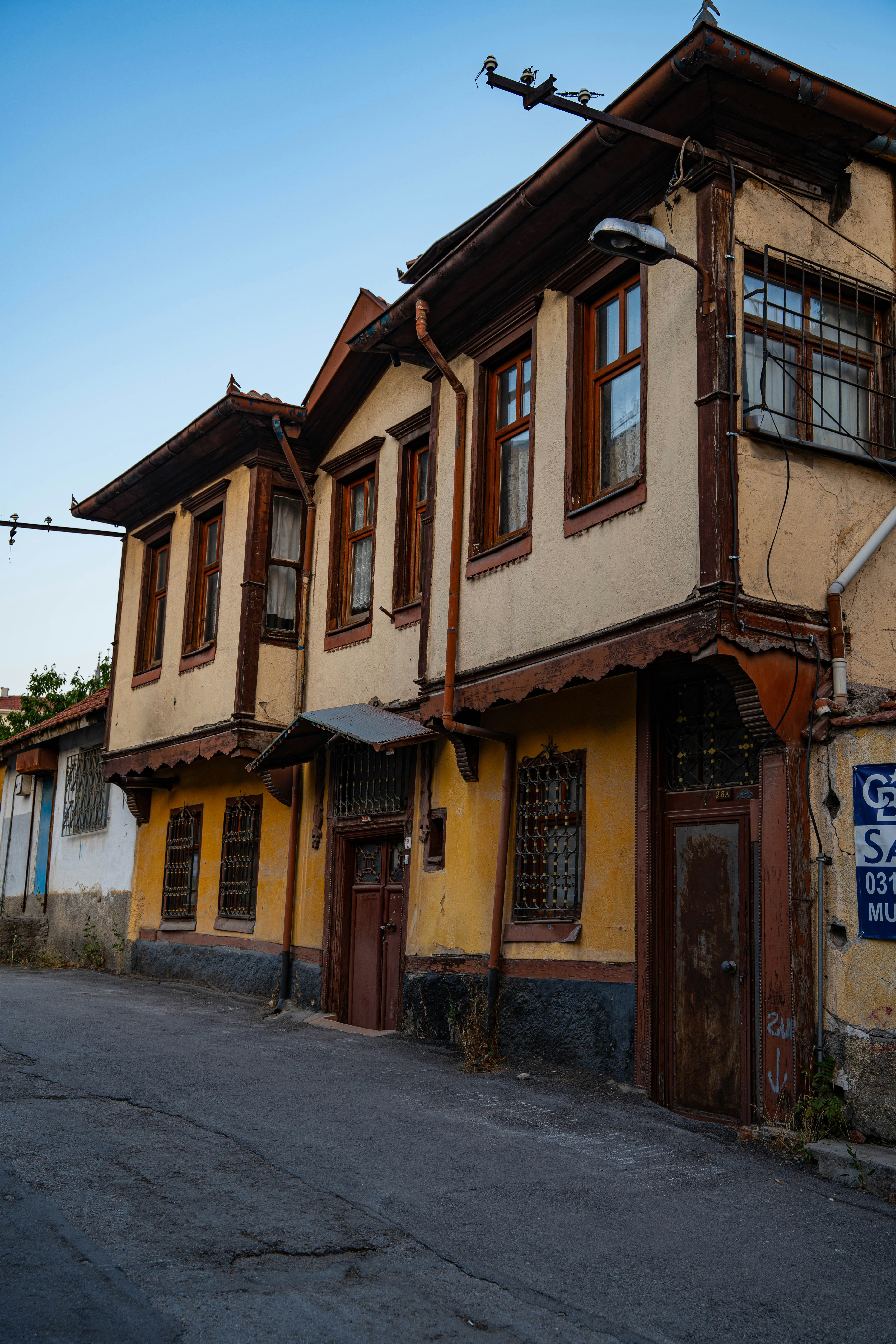 Old House Facade with Sloped Roof and Weathered Walls